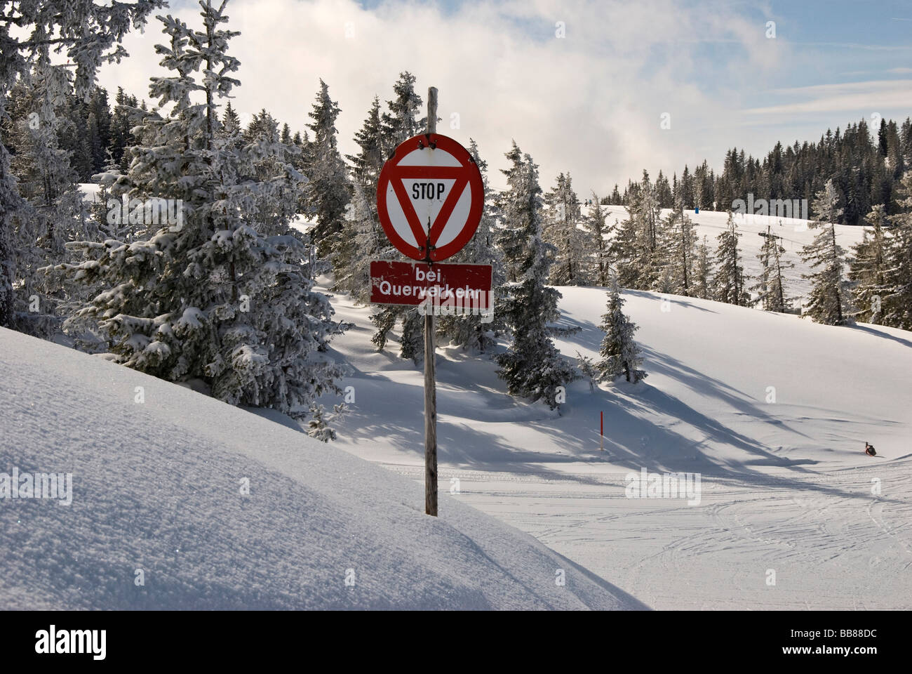 Stop sign at slope crossroad Stock Photo - Alamy