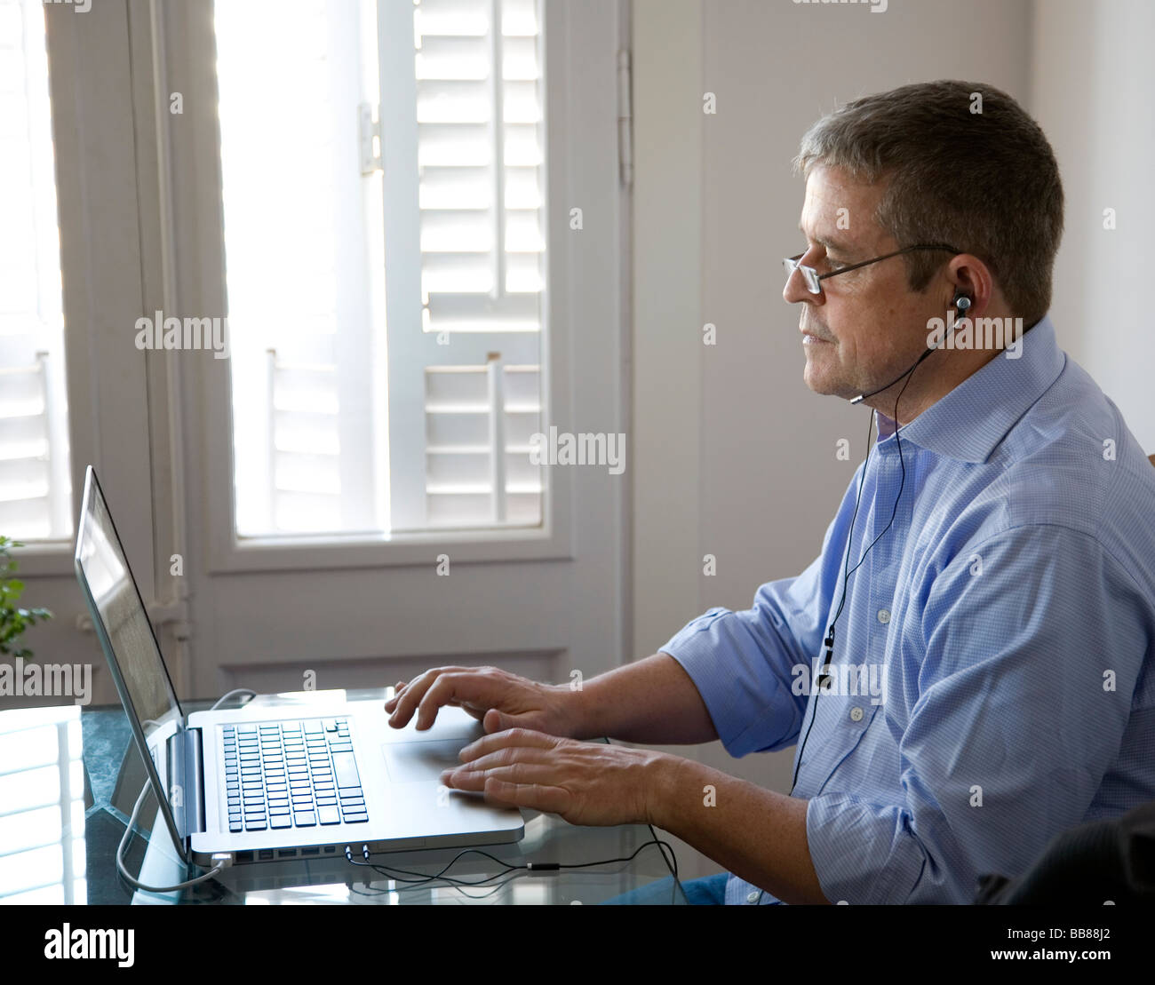 Man at Computor using Skype with Headset Stock Photo - Alamy