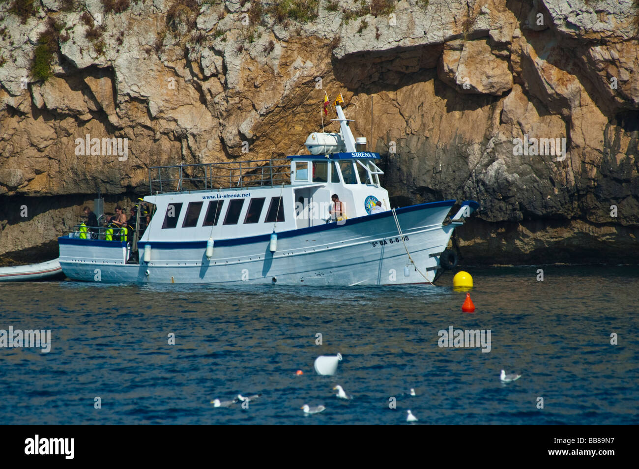 Dive boat with scuba divers anchoring in front of Medes Islands ...