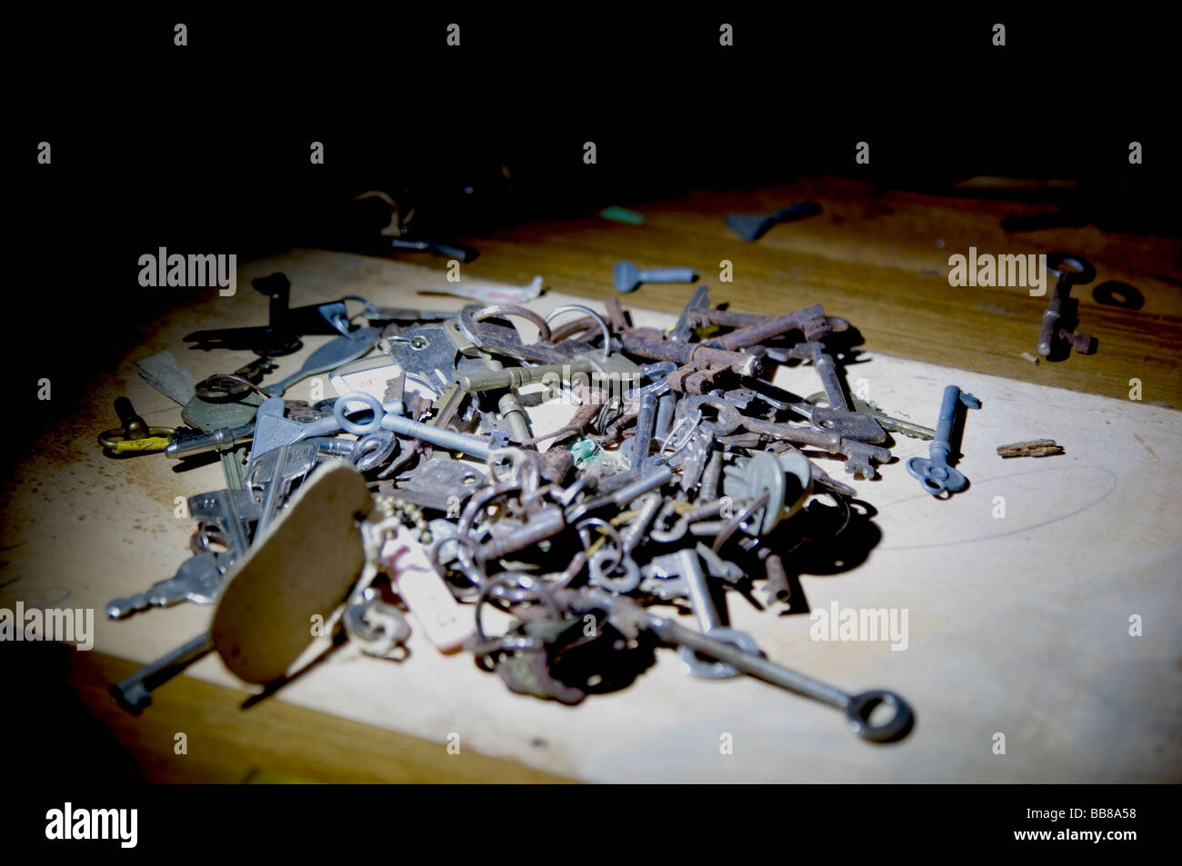 large pile of keys left on a desk in spotlight Stock Photo - Alamy