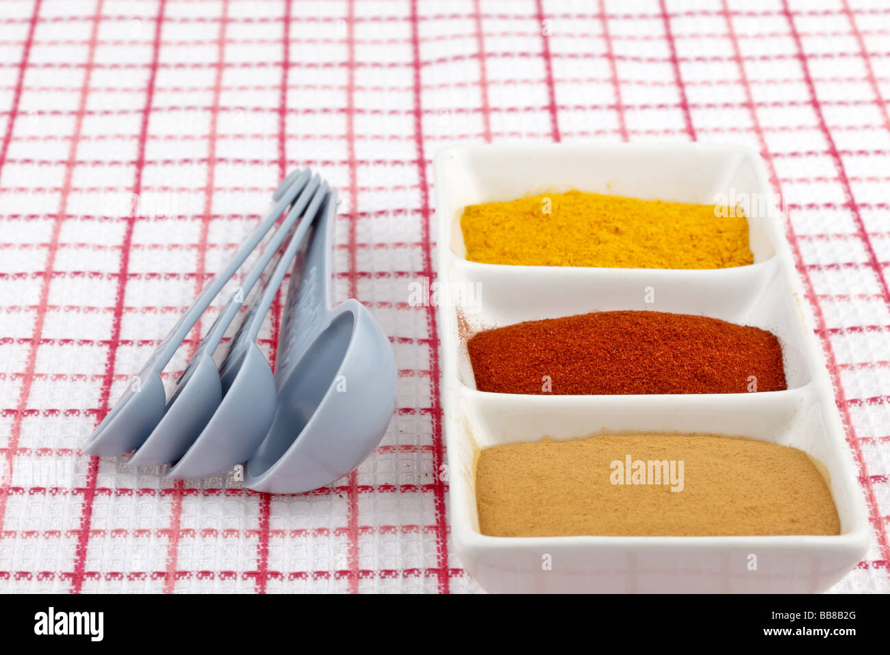 Spices used in cooking with measuring spoons Stock Photo - Alamy