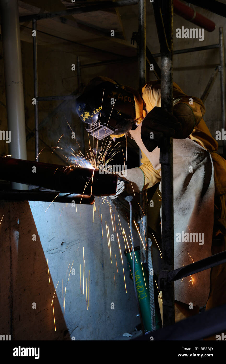Workman welding on a construction site Stock Photo - Alamy