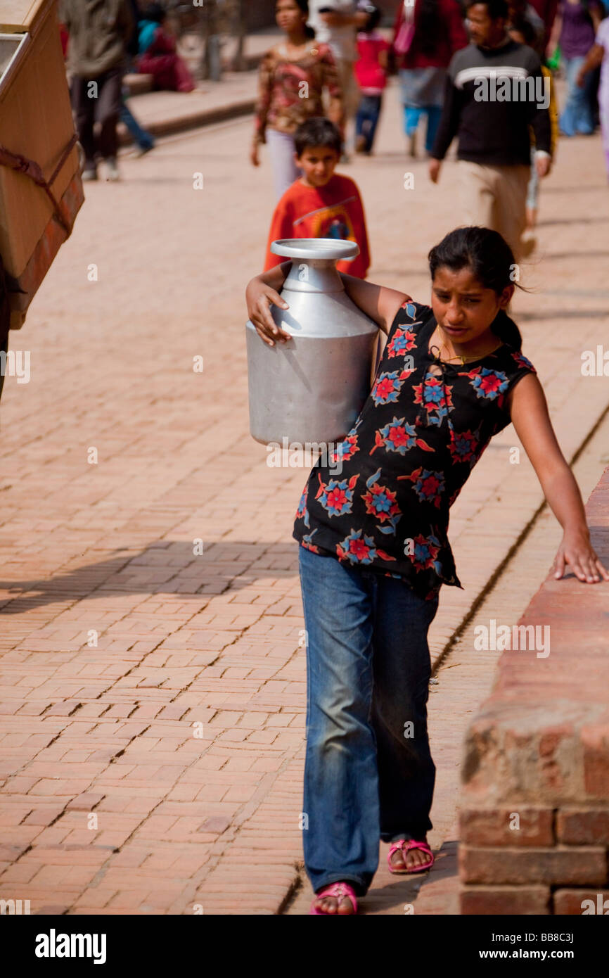 Nepalese woman carrying milk or water jar under her arm 93525 Nepal ...