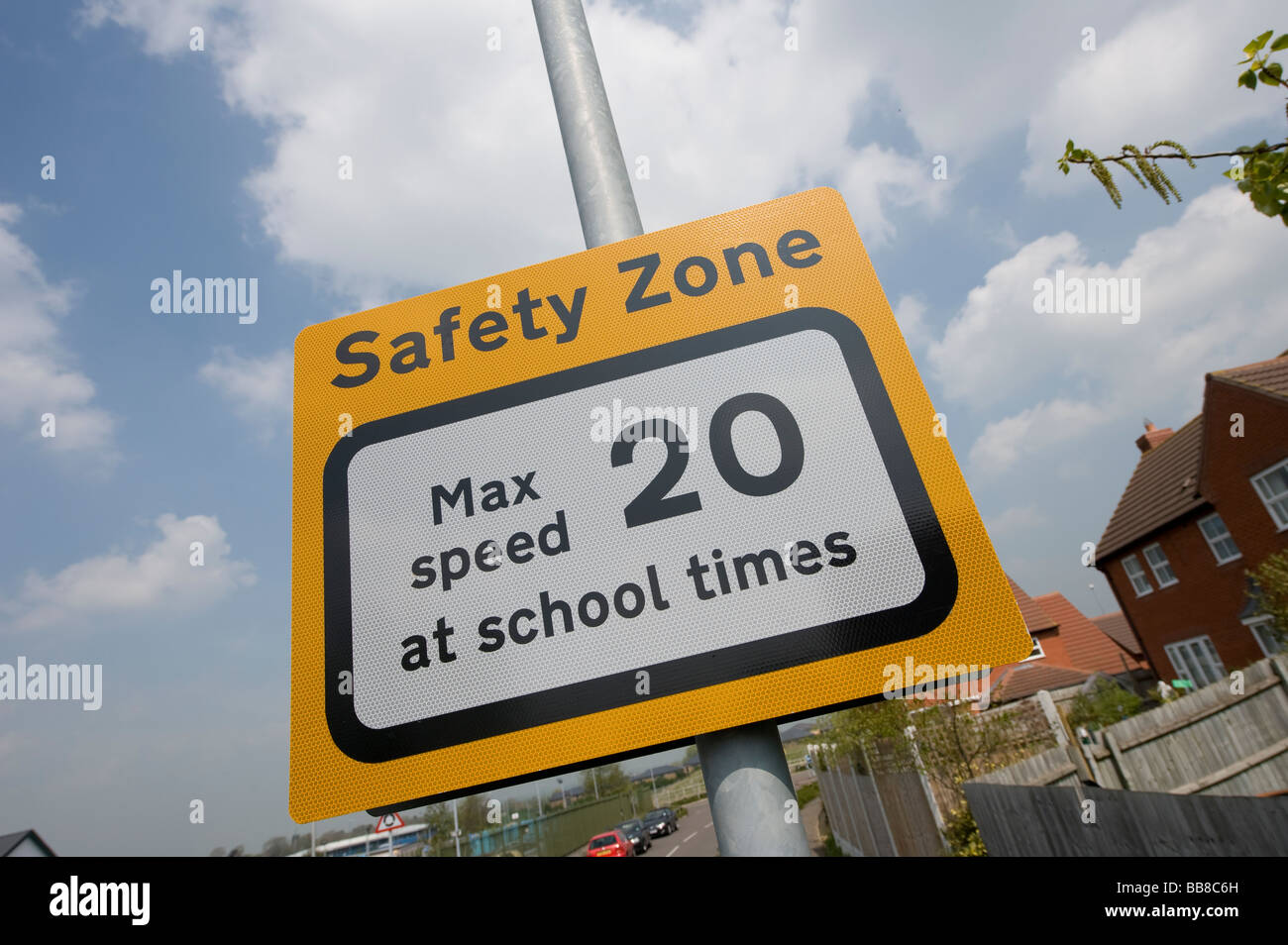Yellow road sign showing a speed limit of 20 miles per hour at school ...