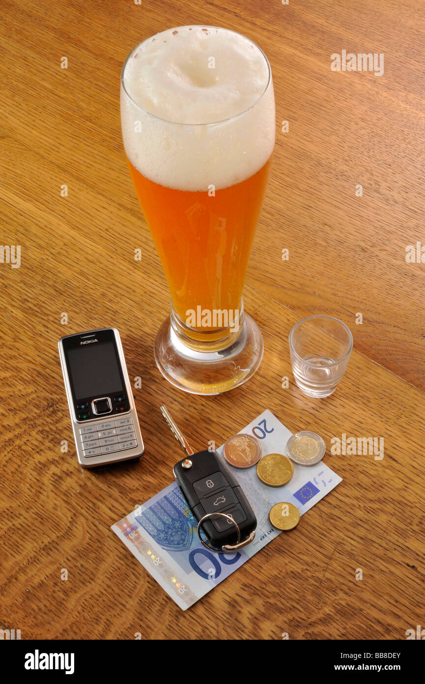 Wheat beer, car keys, symbolic of drink-driving Stock Photo - Alamy