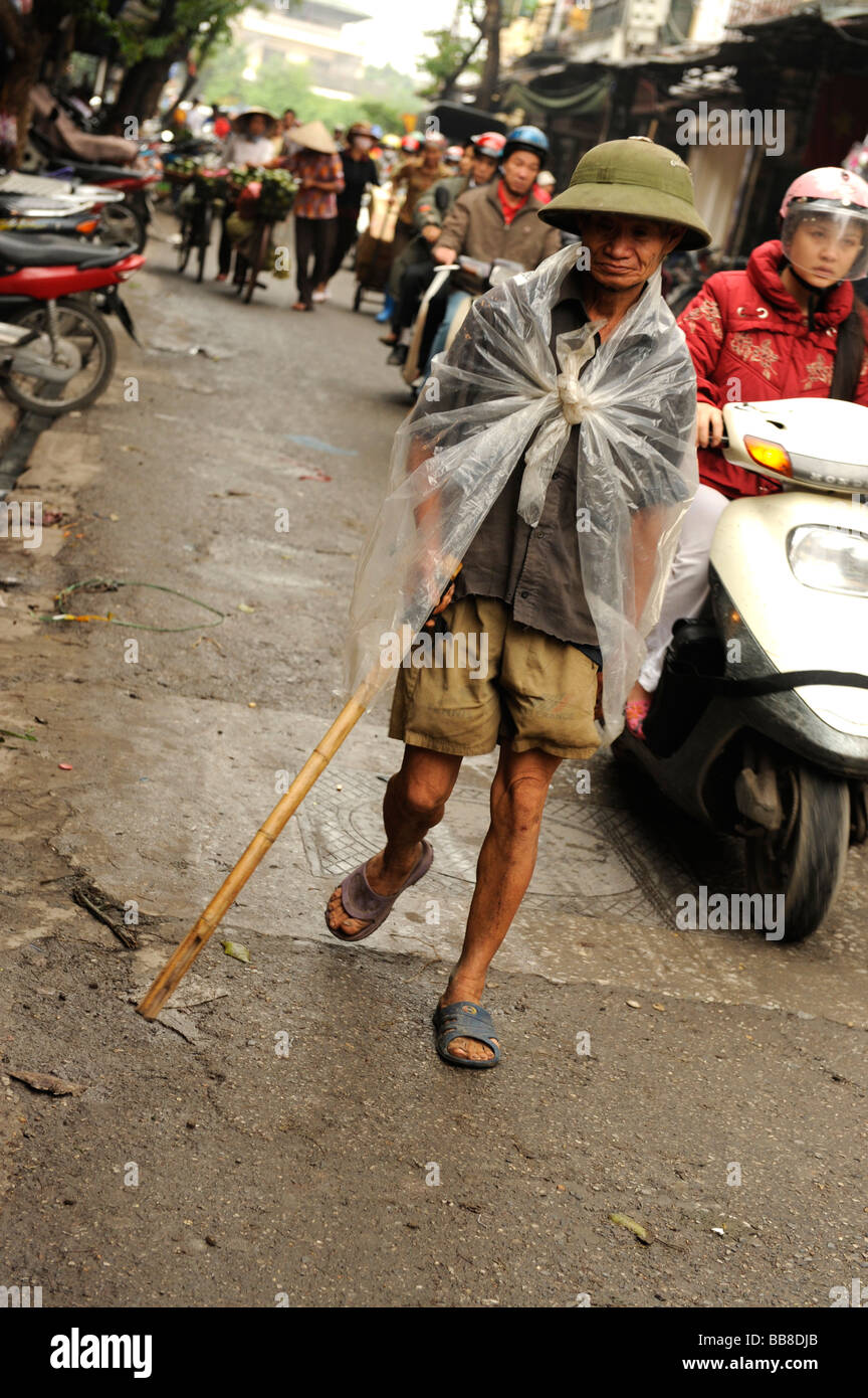 Poor vietnamese guy wear pastic over his top instead of overcoat ...