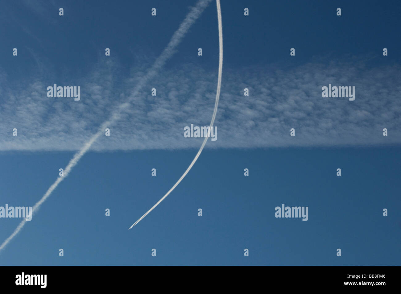 The jet trail from an aircraft passing through a jet streaks from ...