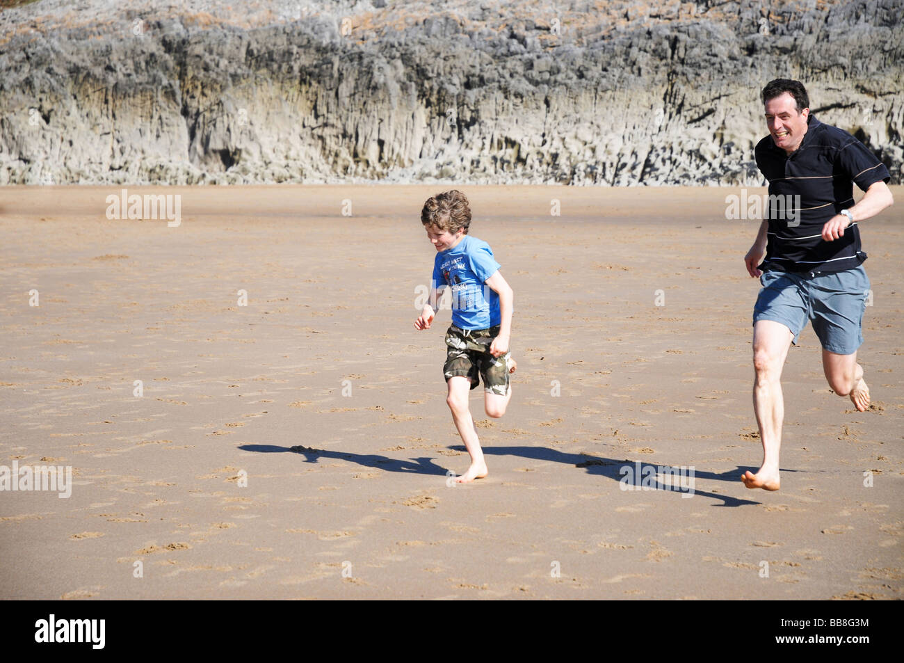 portrait of father and son having a race Stock Photo - Alamy