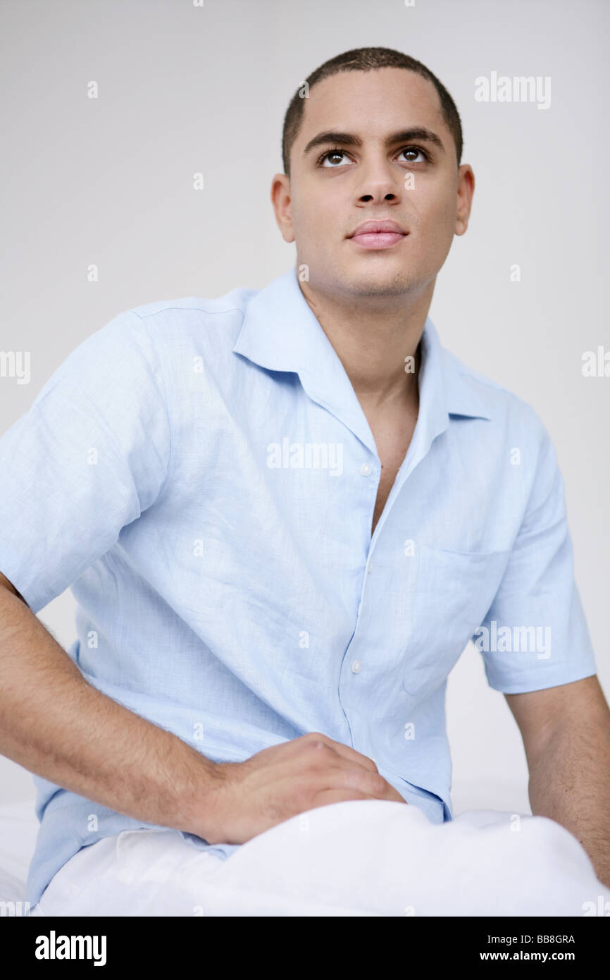 Portrait of a young gentle man sitting Stock Photo - Alamy