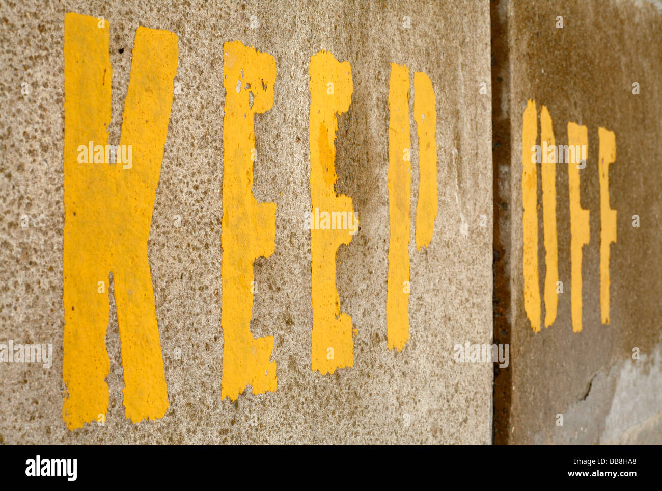 "KEEP OFF" in yellow on a section of concrete Stock Photo - Alamy