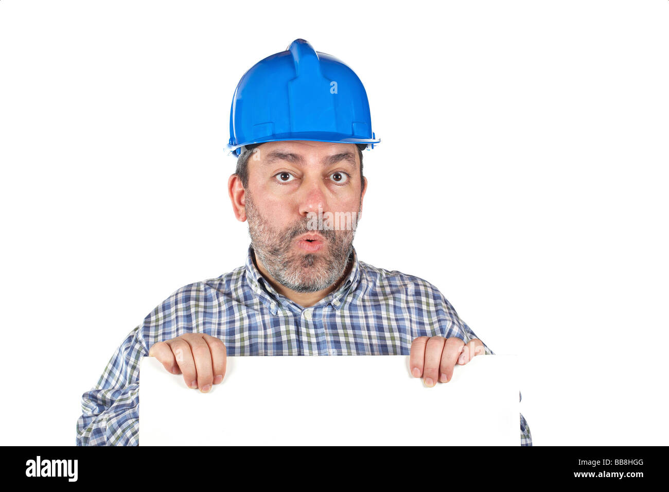 Surprised and curious construction worker in a blue hardhat behind the ...