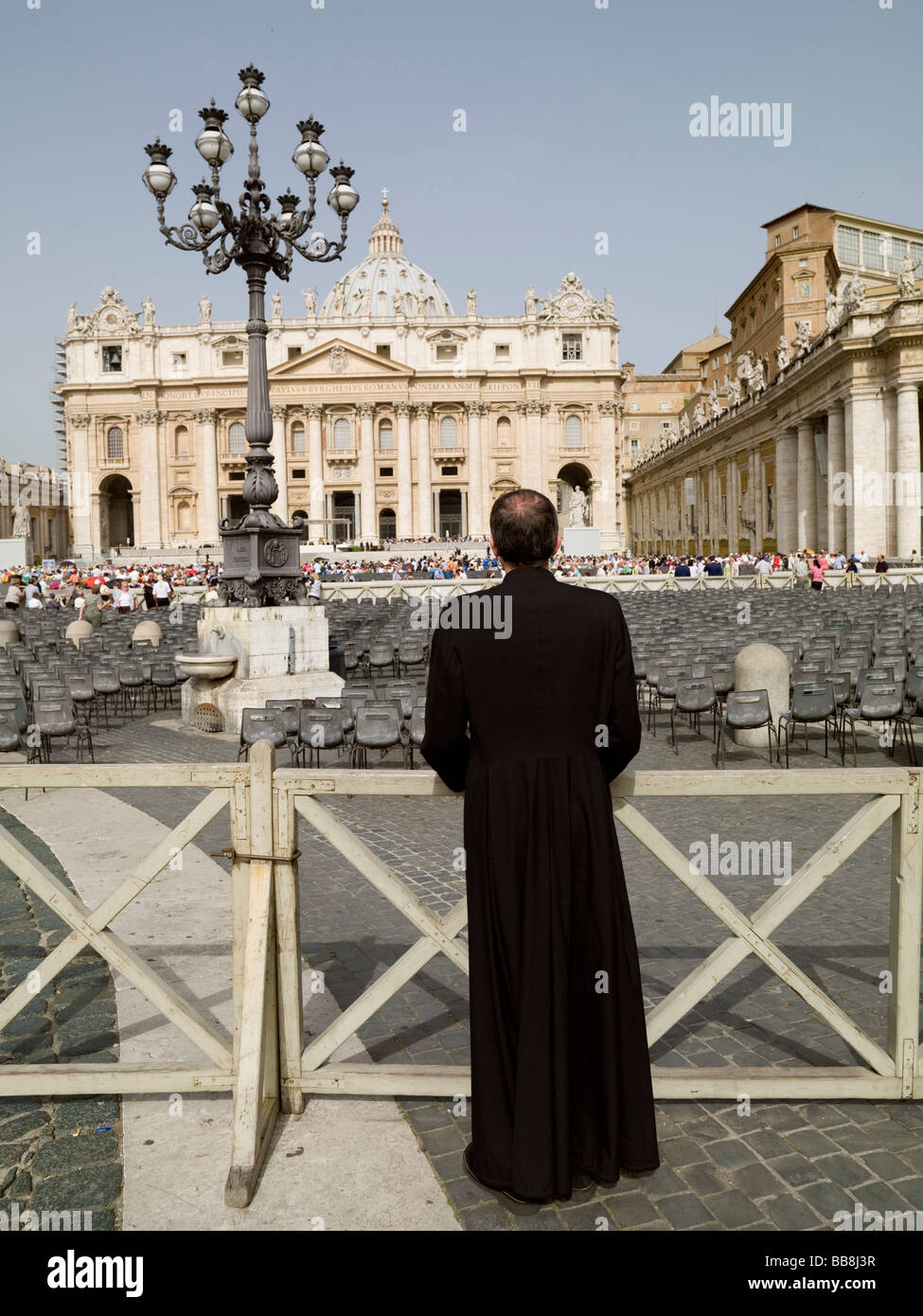 Rear view of priest watching St. Peter's Square; Rome, Italy Stock ...