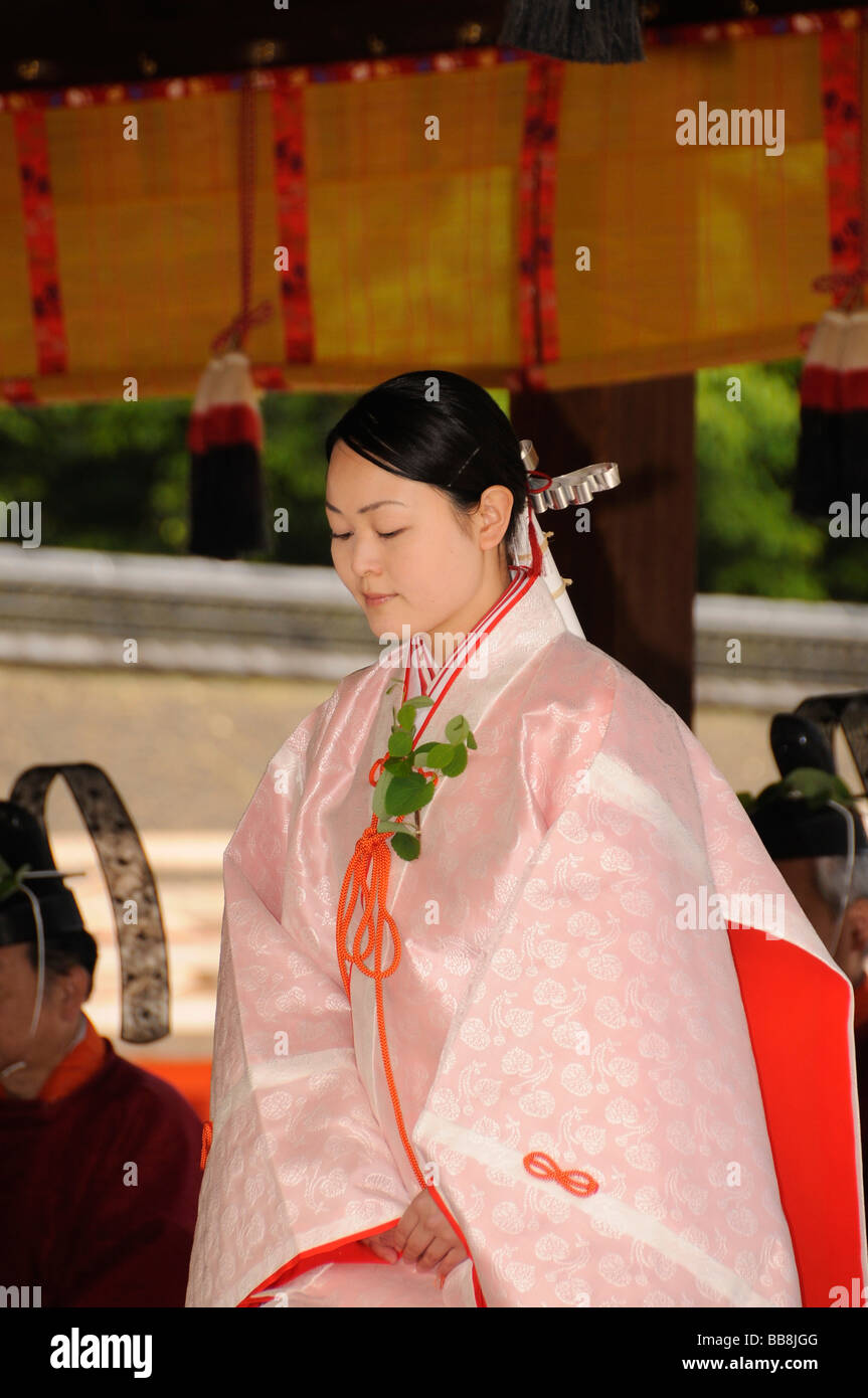 Miko, temple servant, at a ritual ceremony at the Shimogamo Shrine ...