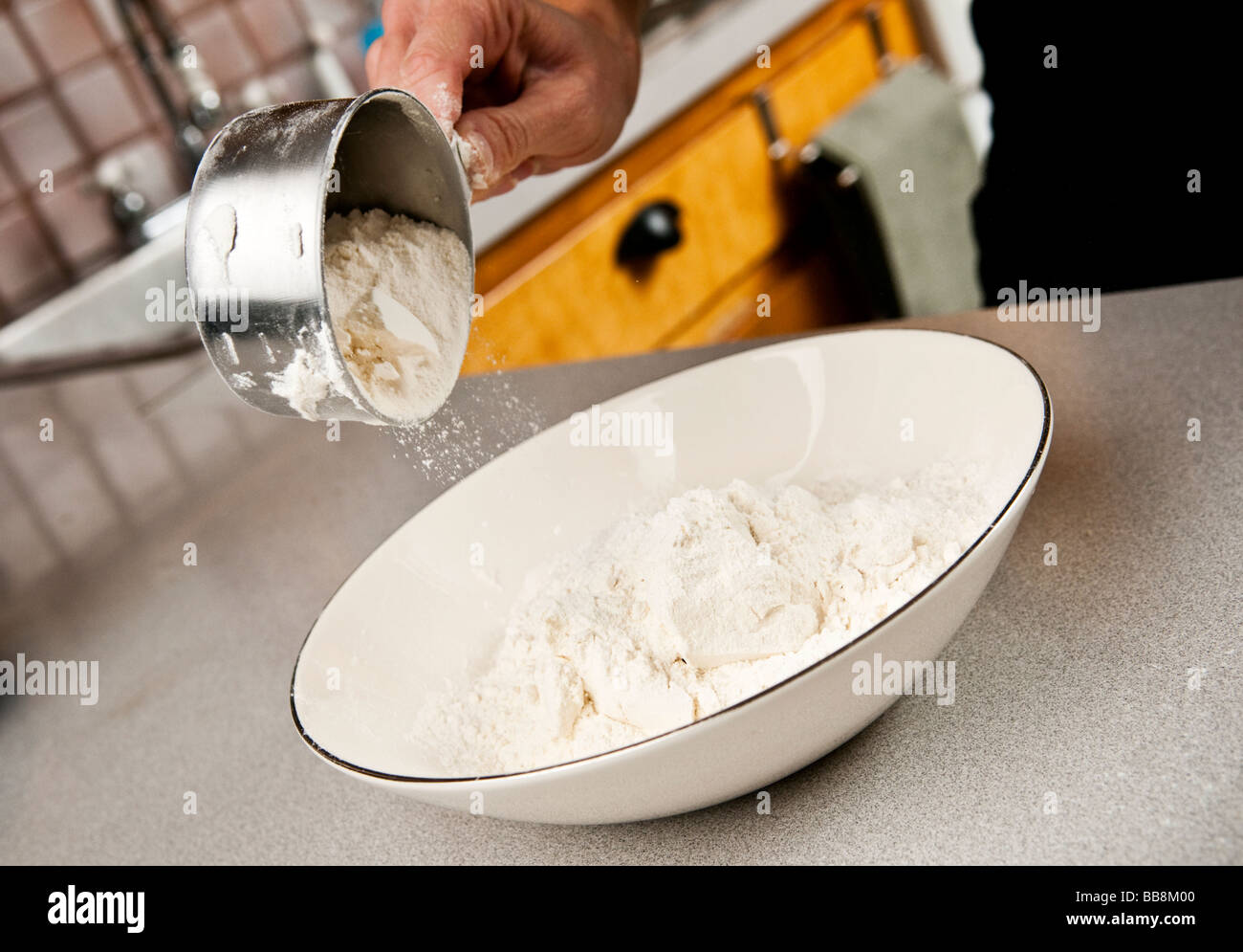 Mixing ingredients baking adding flour hi-res stock photography and ...