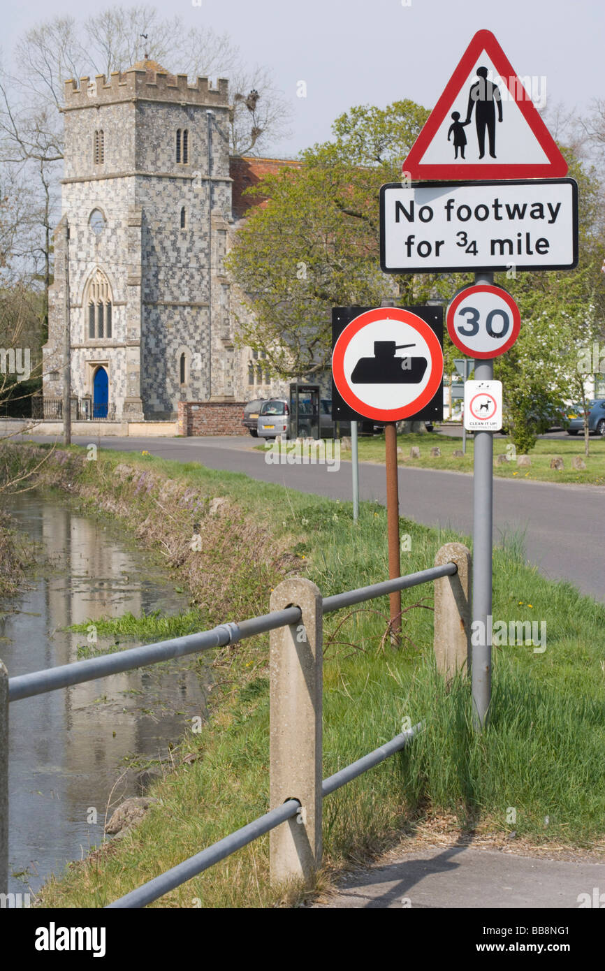 Traffic signs against All Saints Church, Chitterne, Wiltshire, England ...