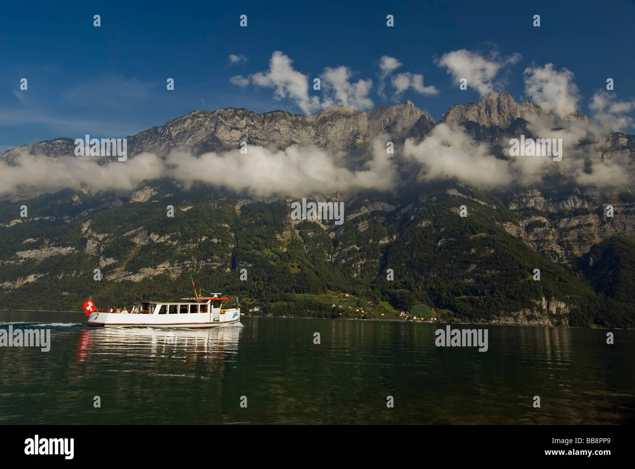 Walensee lake, boat with tourists and Churfirsten mountainchain ...