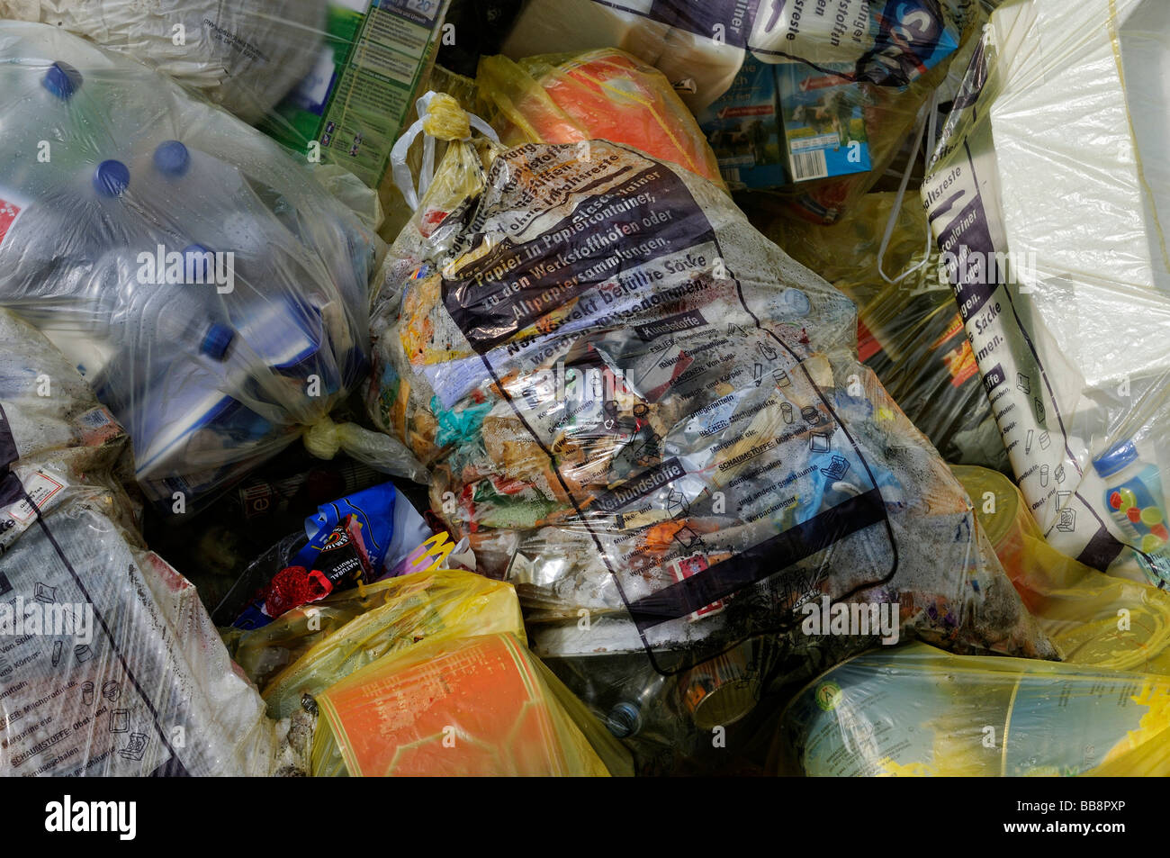 Garbage filled yellow sacks to be recycled Stock Photo - Alamy