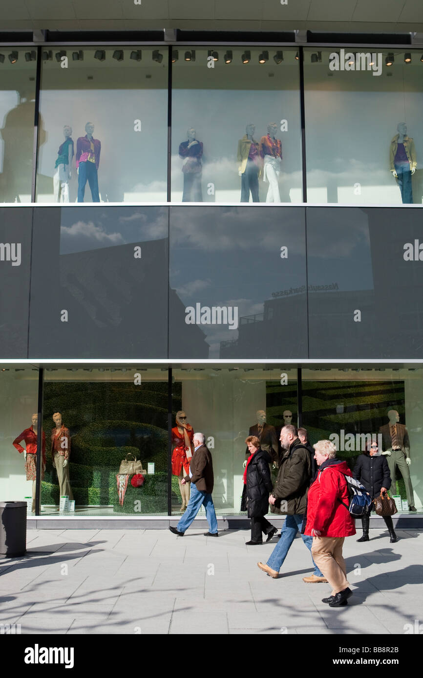 Shopping mall with shop window dummies and crowds in the city of ...