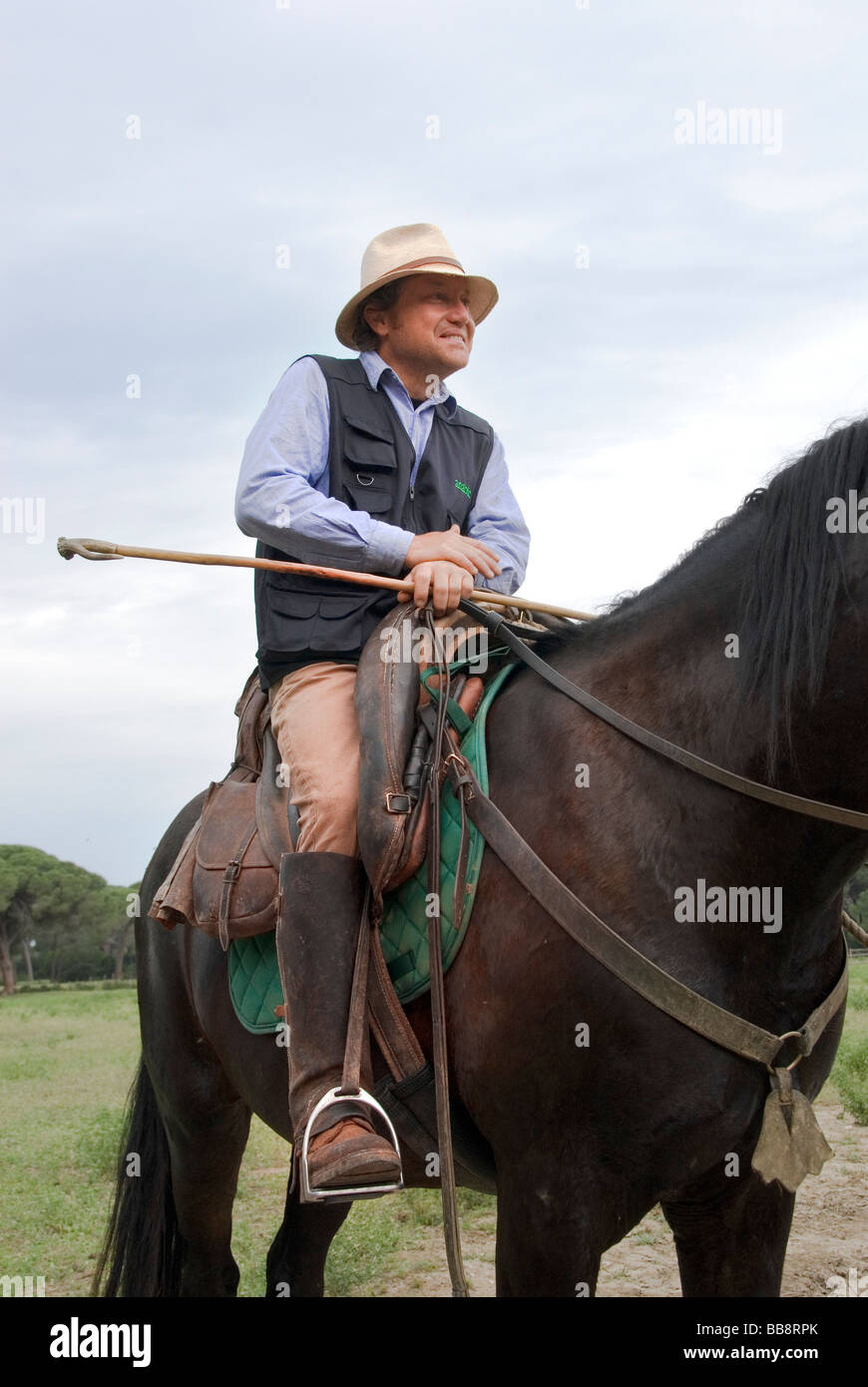Maremma cowboy called Butteri on his work horse, he wears traditional ...