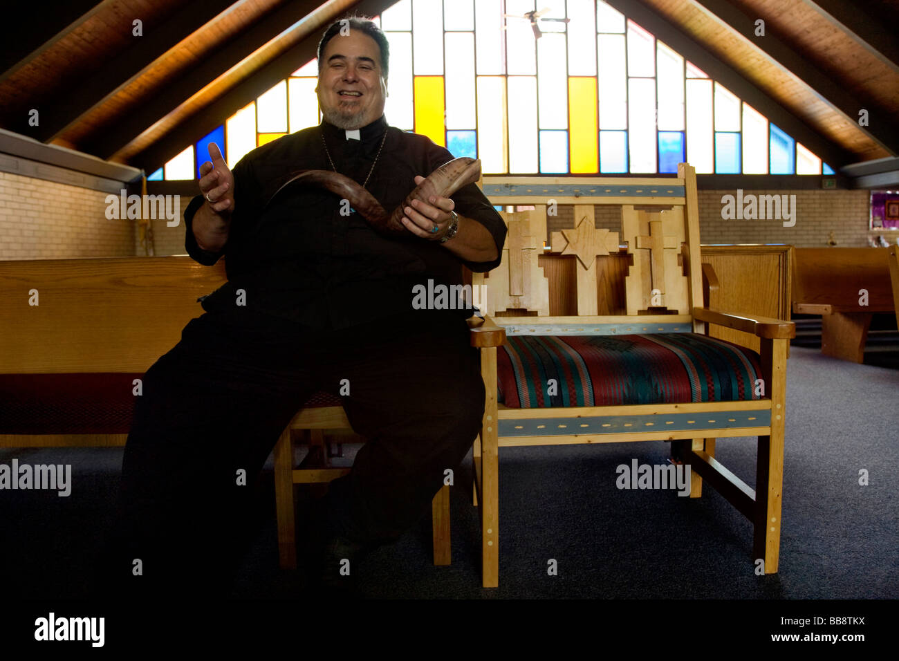 Hispanic priest with a shofar at the alter of his Catholic church in ...
