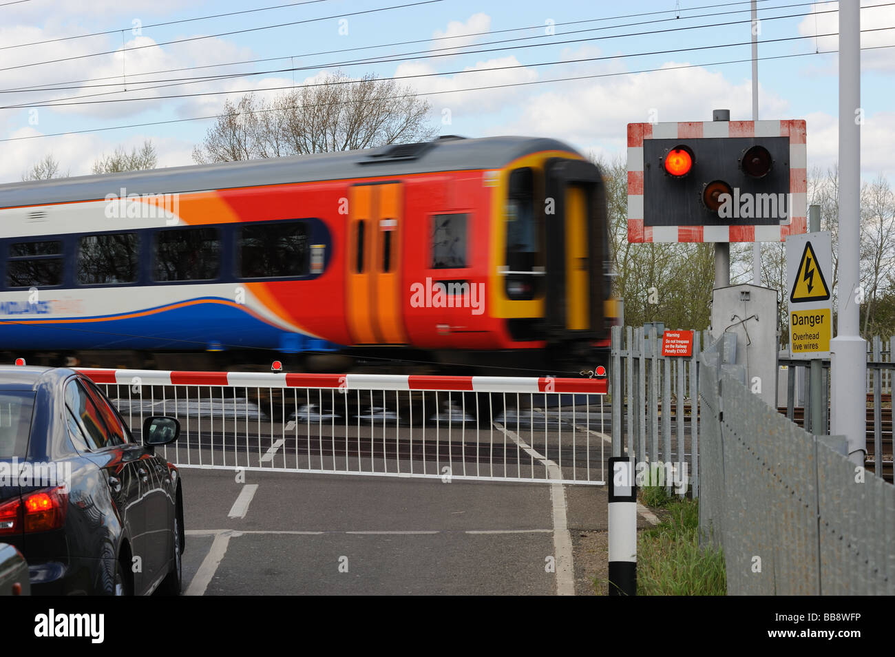 Level crossing safety. A speeding train at Lolham north of Peterborough ...