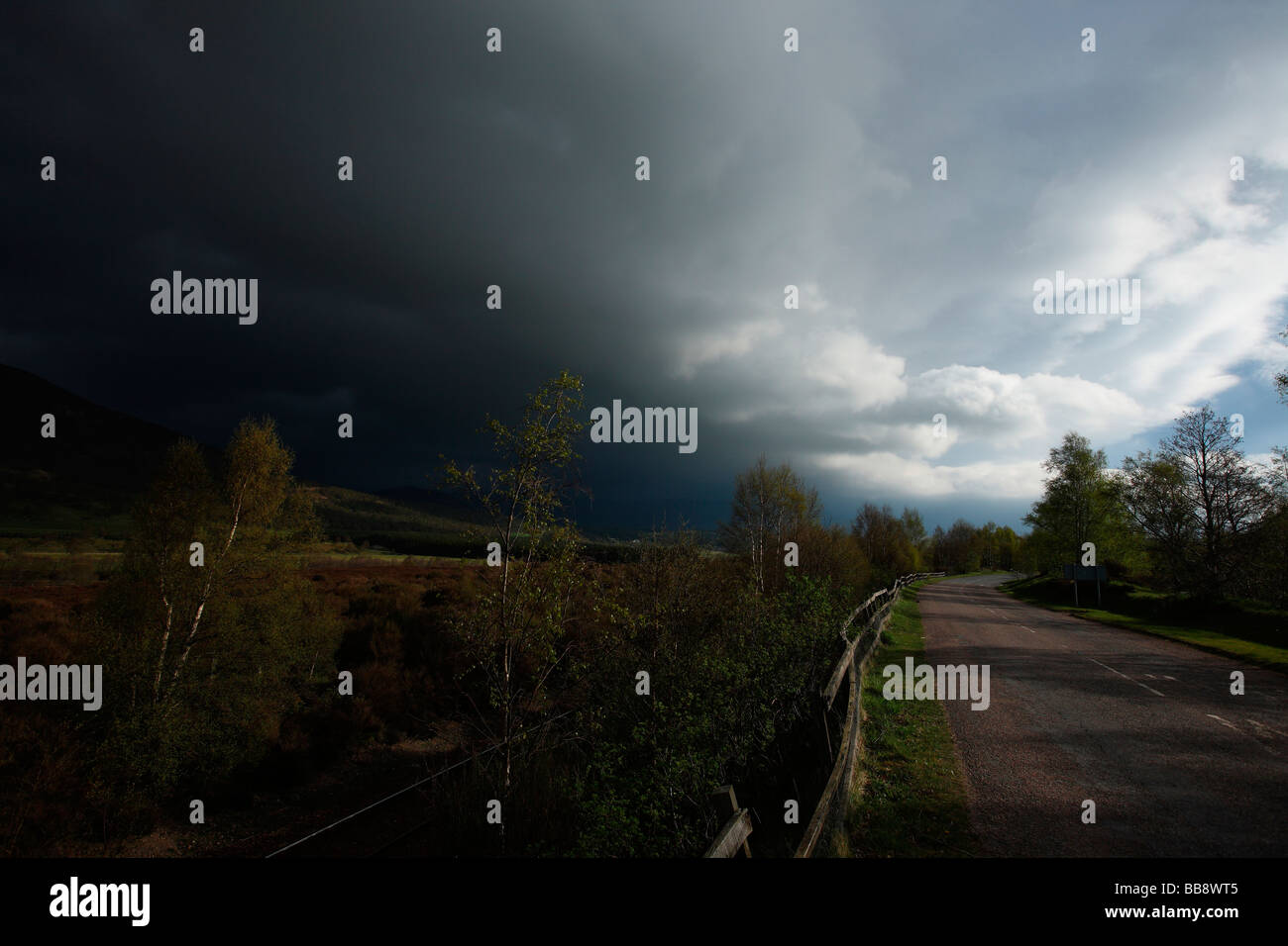 Scottish road side with bright sunshine and stormy dark clouds Scotland ...