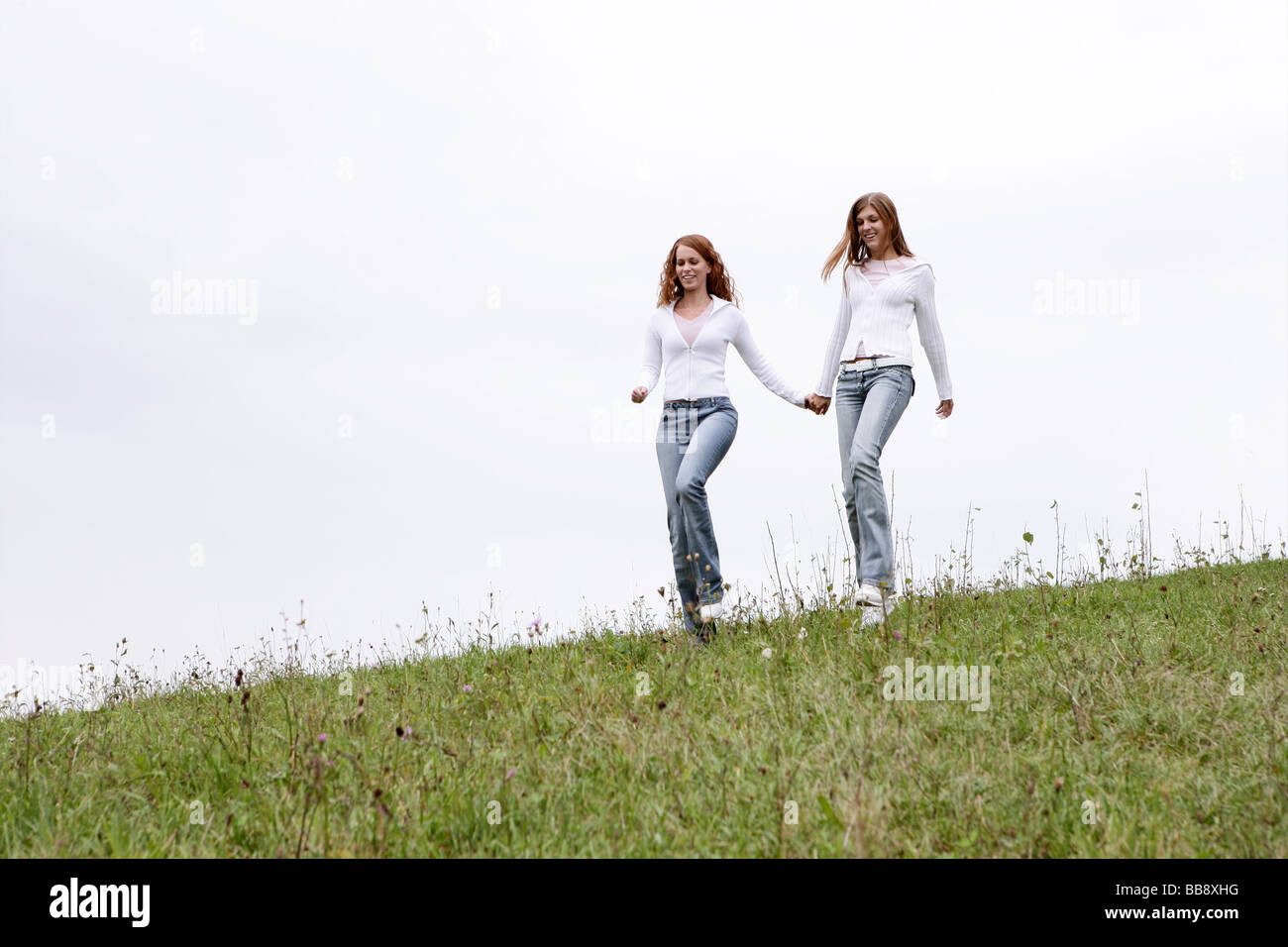 Two teenagers walking on a field Stock Photo - Alamy