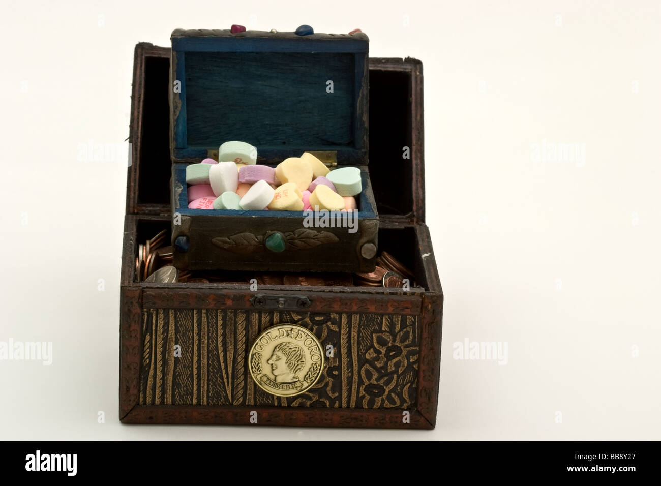 Small treasure chest filled with heart shaped candies on a larger chest ...