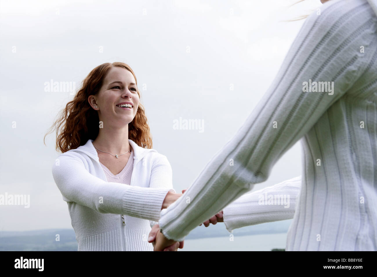 Two teenagers dancing on a field with lake view Stock Photo - Alamy