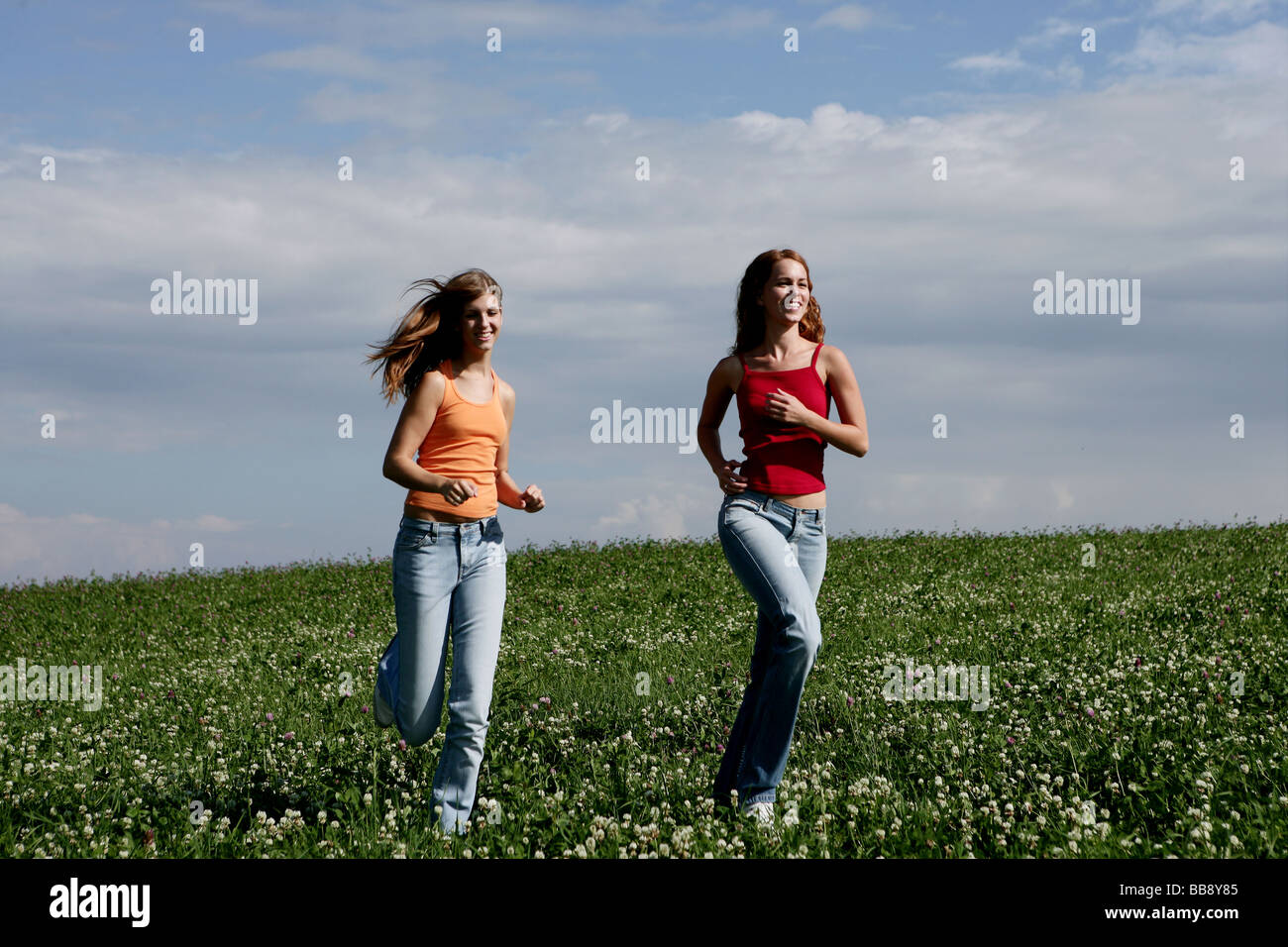 Two teenagers running on a field Stock Photo - Alamy