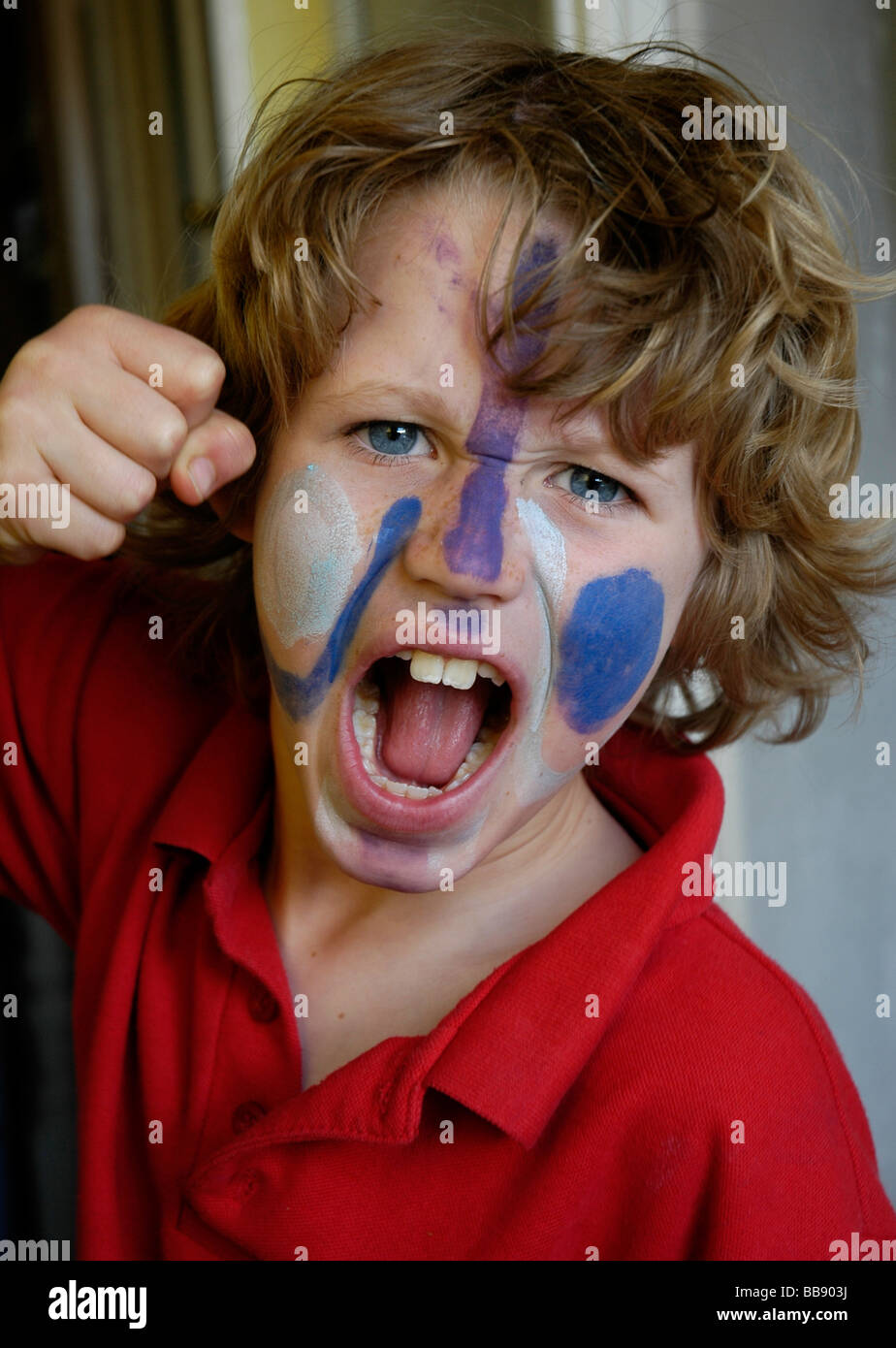 A young boy with facepaint shows aggression Stock Photo - Alamy