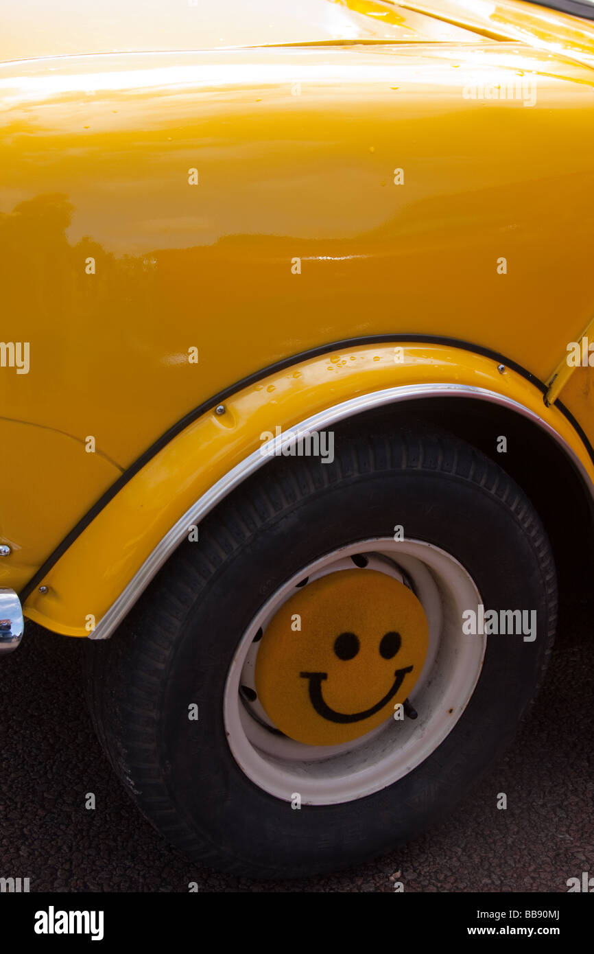 Yellow hub cap with smiley Stock Photo - Alamy