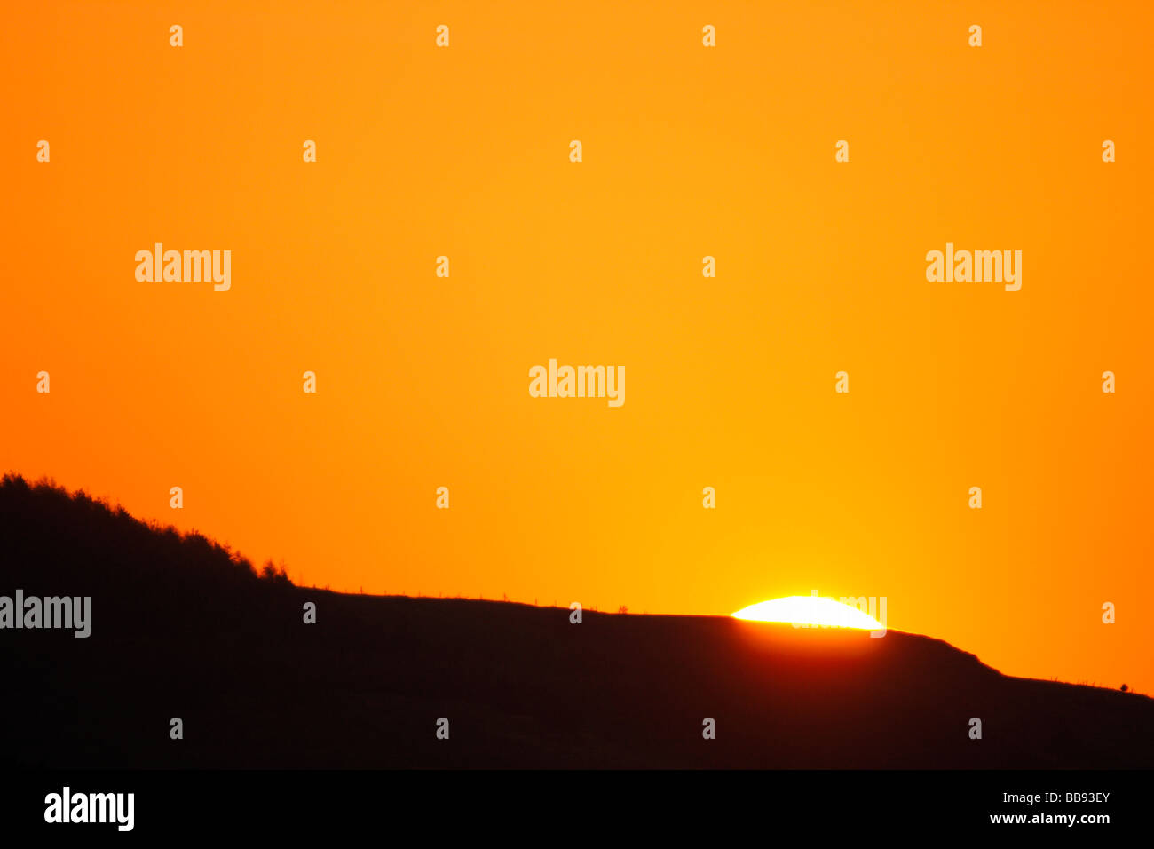 Sun Rising Over a Hillside Stock Photo - Alamy