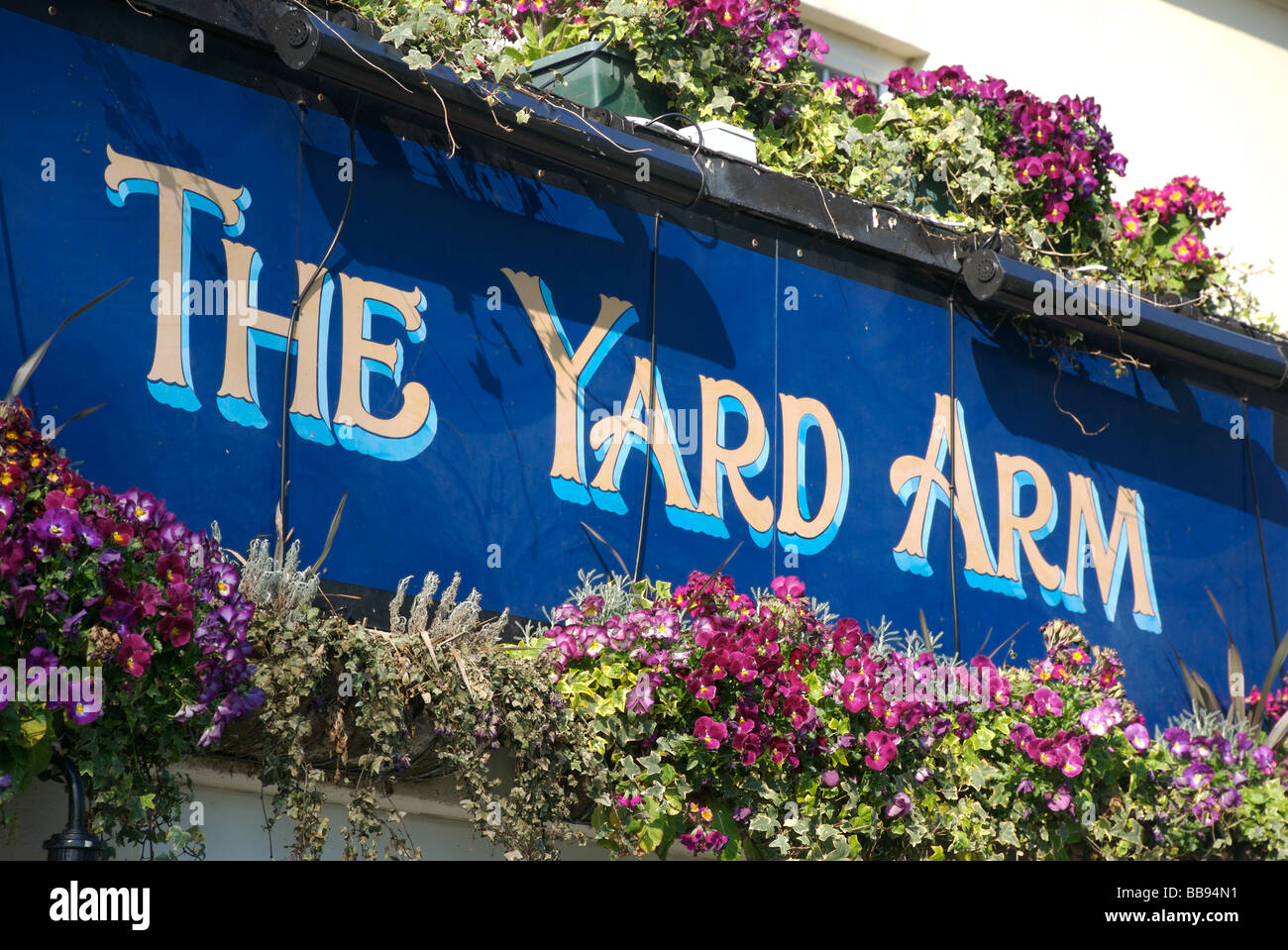 The Yard Arm pub sign with flower display, Plymouth, Devon, UK Stock ...