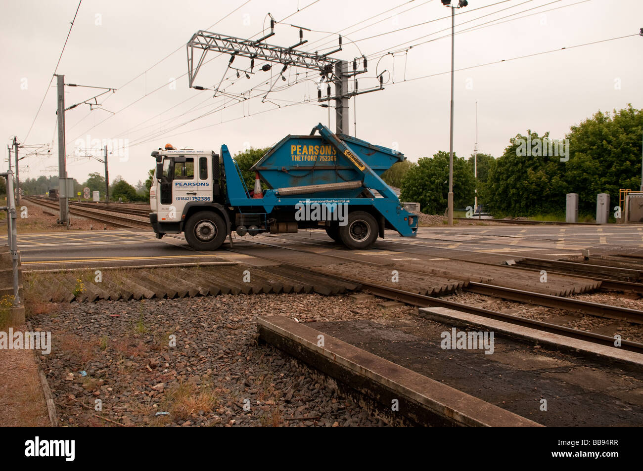 Skip Lorry crossing the railway lines on a 'Level Crossing" near Ely ...
