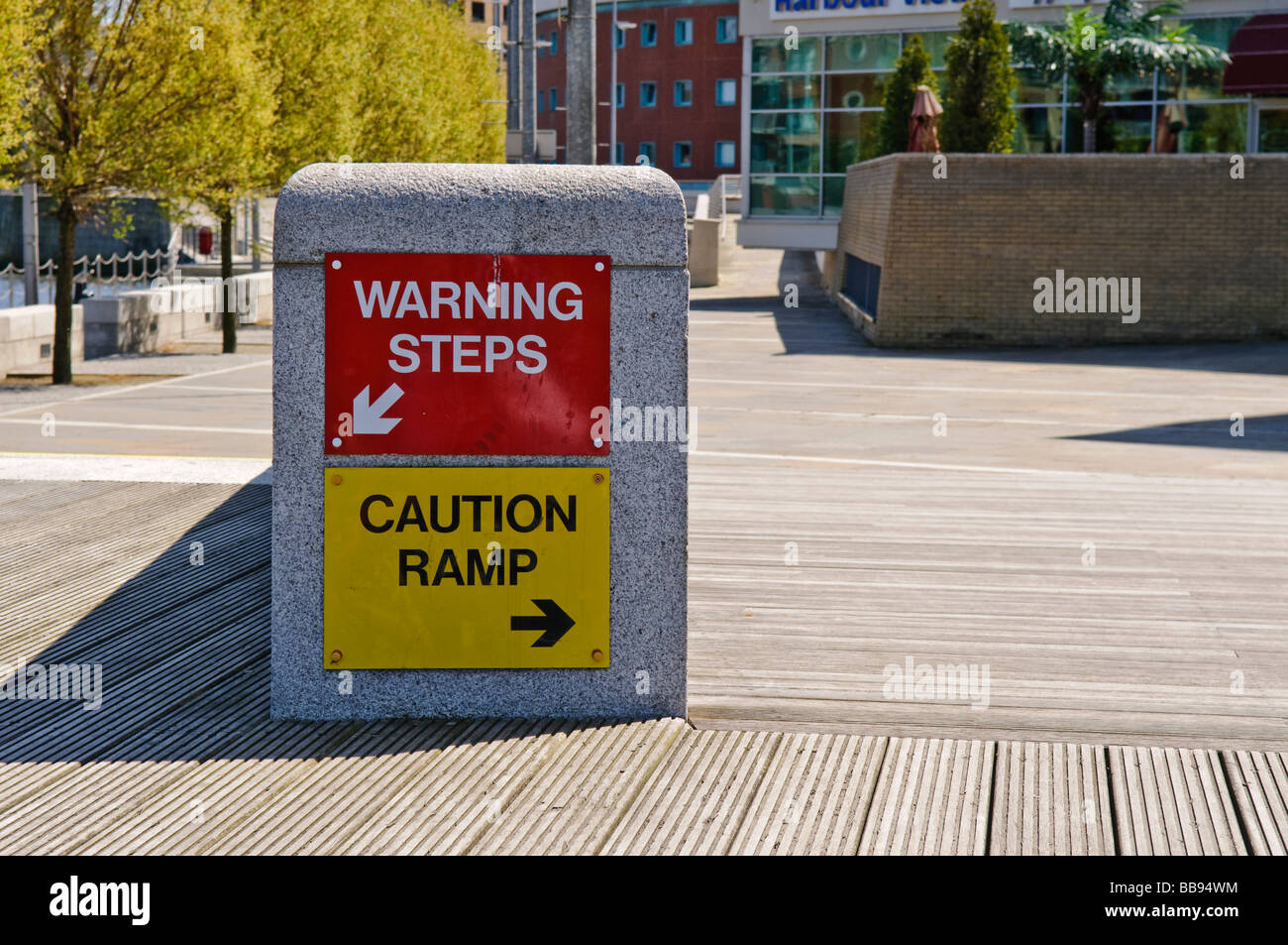 Two warning signs "Warning steps" and "Caution ramp" beside each other ...