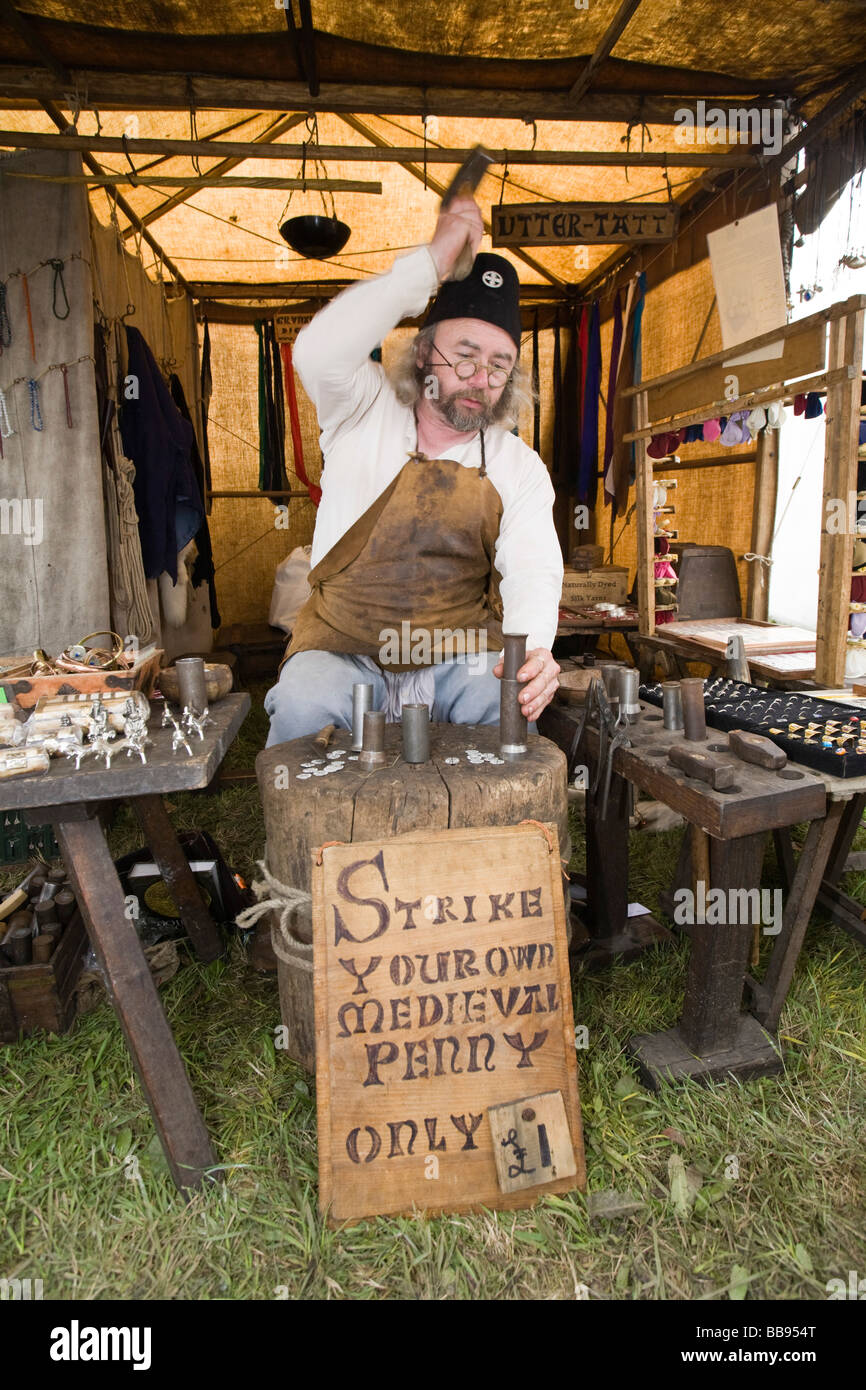 Medieval coin-maker striking coins at Tewkesbury Medival Festival 2008 ...