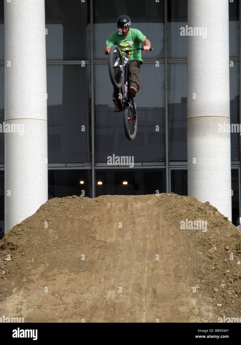 person doing bike stunts on earth ramp at event outdoors in rome italy ...