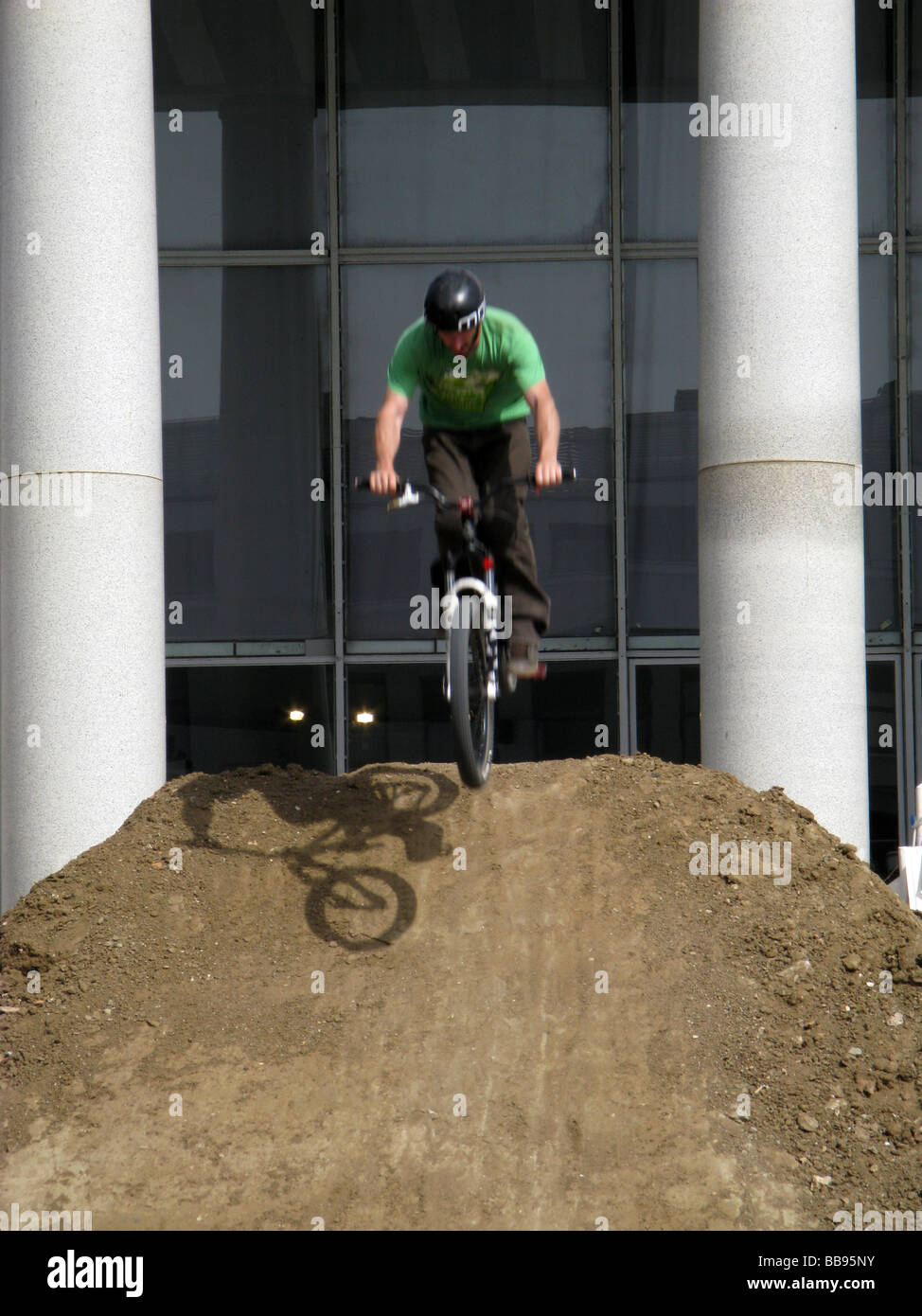 person doing bike stunts on earth ramp at event outdoors in rome italy ...
