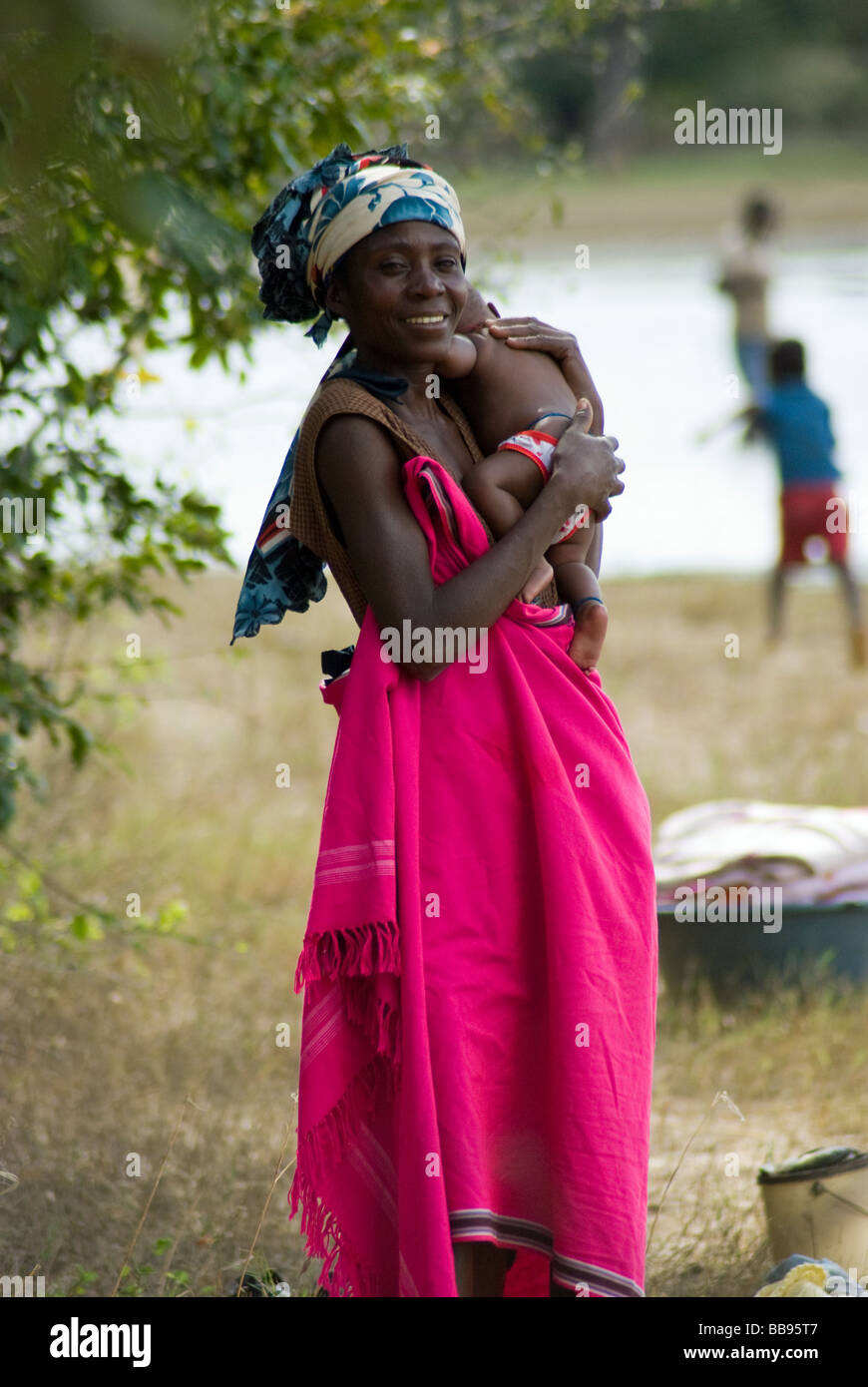 Portrait of a mother with her baby on the banks of the Okavango River ...