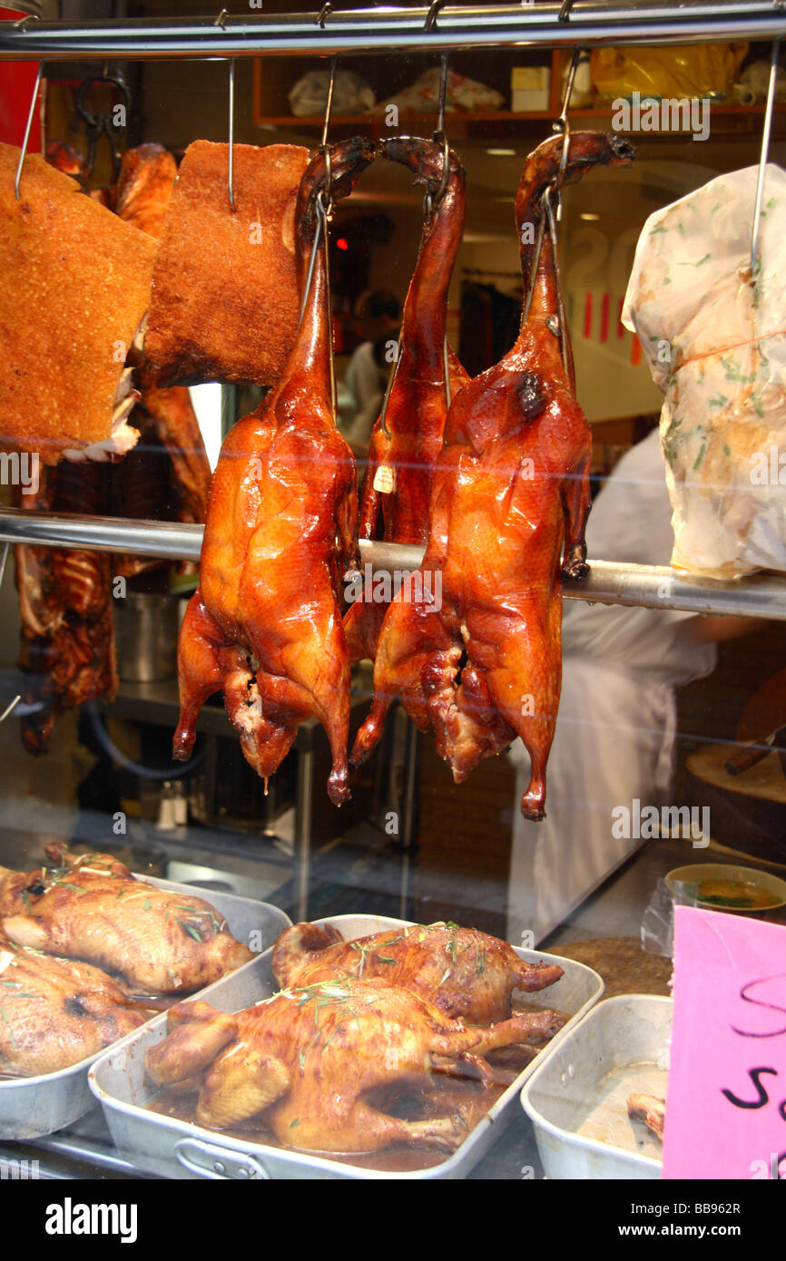 Meat on display in a butcher store shop window in Chinatown, New York ...