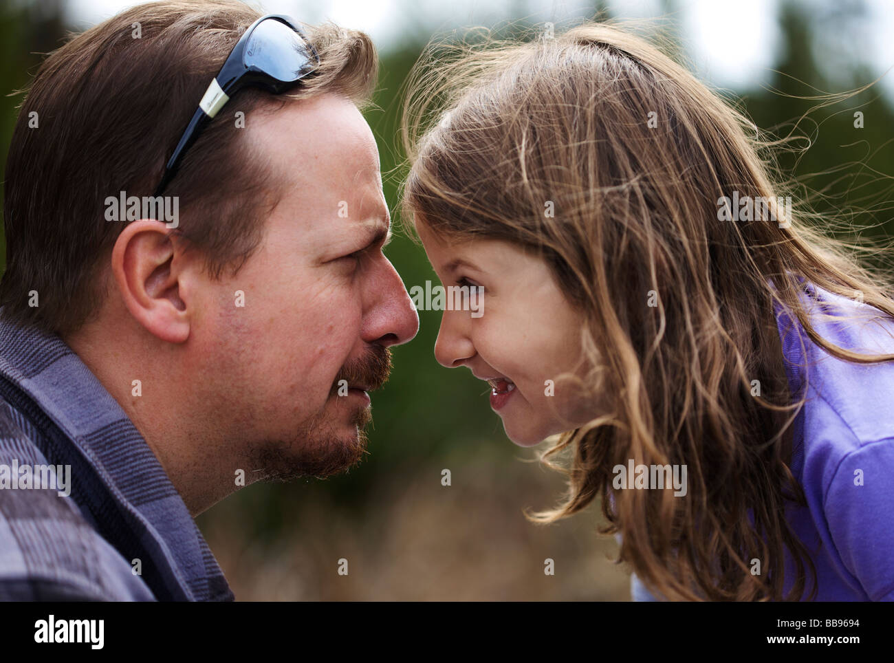 Happy young girl starring each other playfully with her father Stock ... Happy young girl starring each other playfully with her father Stock ...