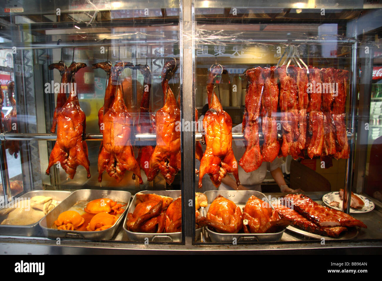 Meat on display in a butcher store shop window in Chinatown, New York ...