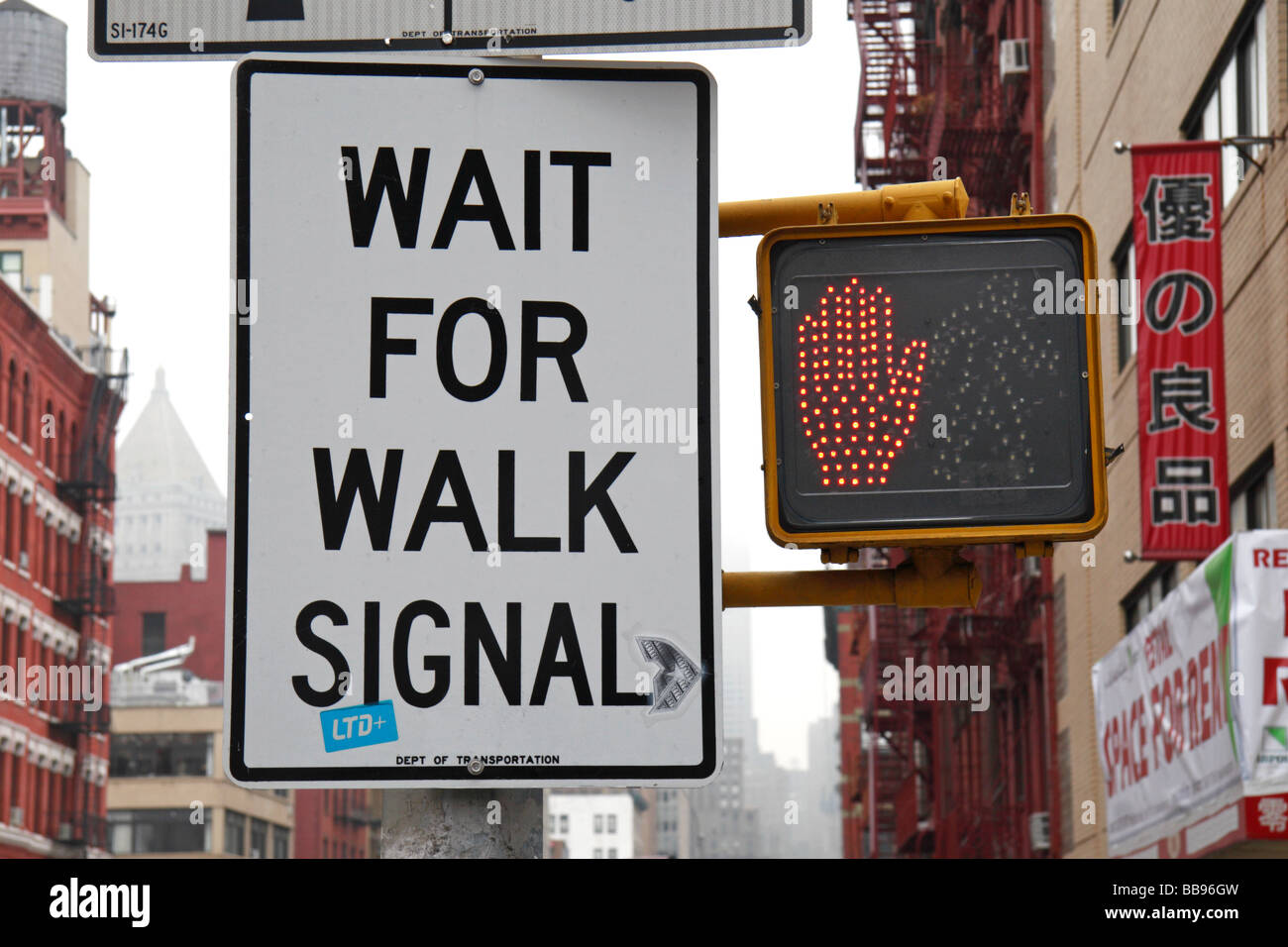 A 'Wait for Walk Signal" sign at a sidewalk road crossing in Chinatown ...