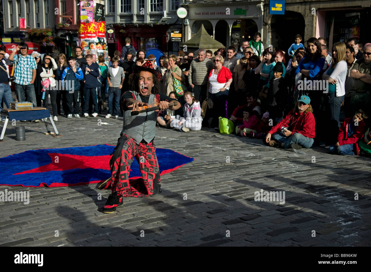Street Performer entertains audience with fire torch Edinburgh Fringe ...