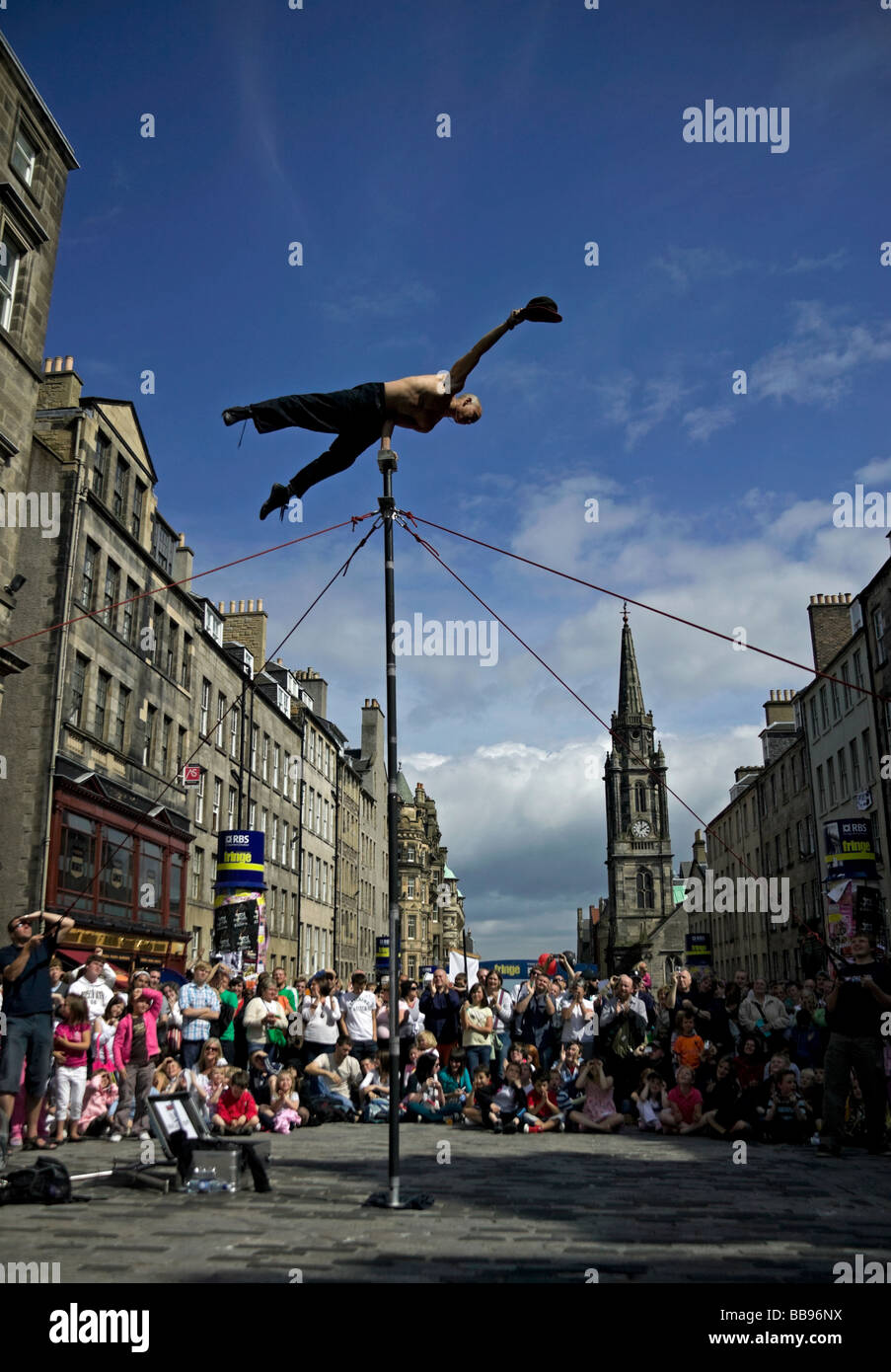 Street Performers entertains audience balancing on pole Edinburgh ...