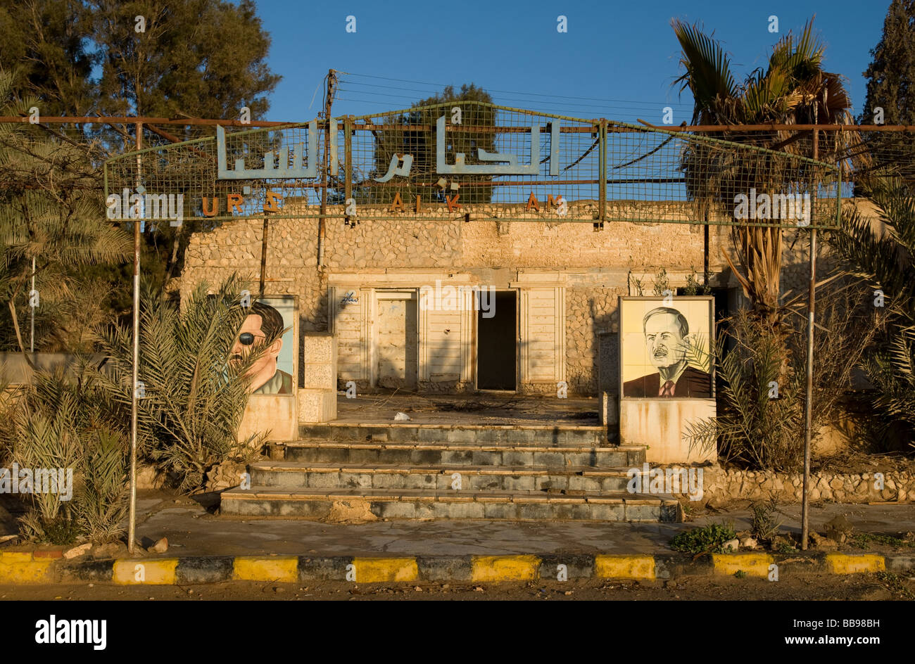 A derelict building with portraits of Bashar al Assad and his late ...
