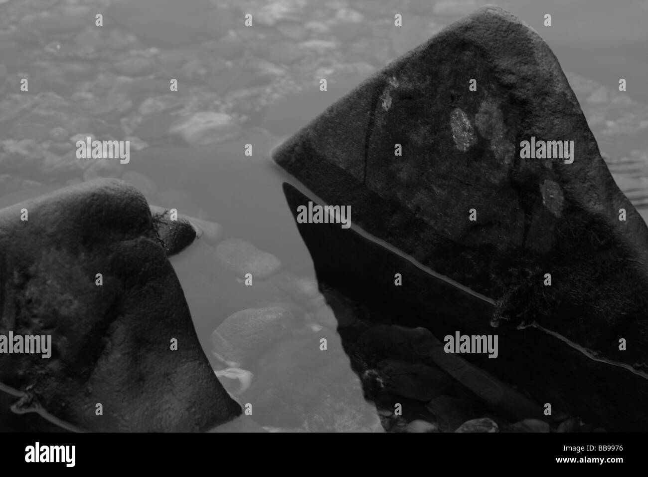 Two triangular stones emerging from a body of water Stock Photo - Alamy