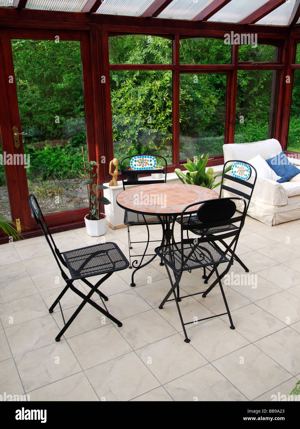 conservatory tables chairs plants room in house next to garden Stock ...