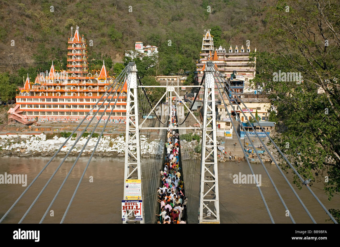 Pedestrinas crossing Lakshman Jhula suspension bridge over Ganges river ...